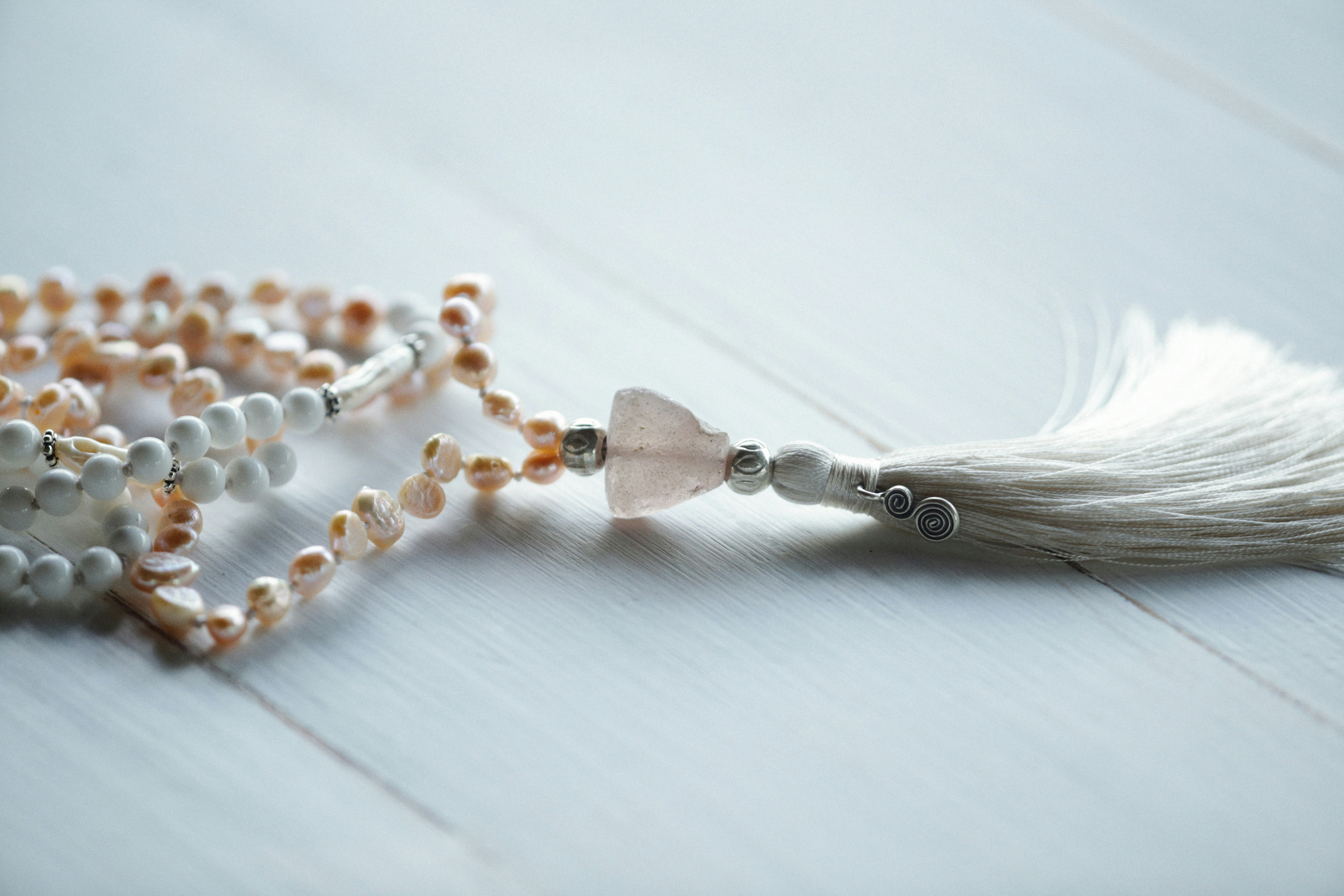 A tassel of beads and a tassel of beads on a table photo – Free Grey ...