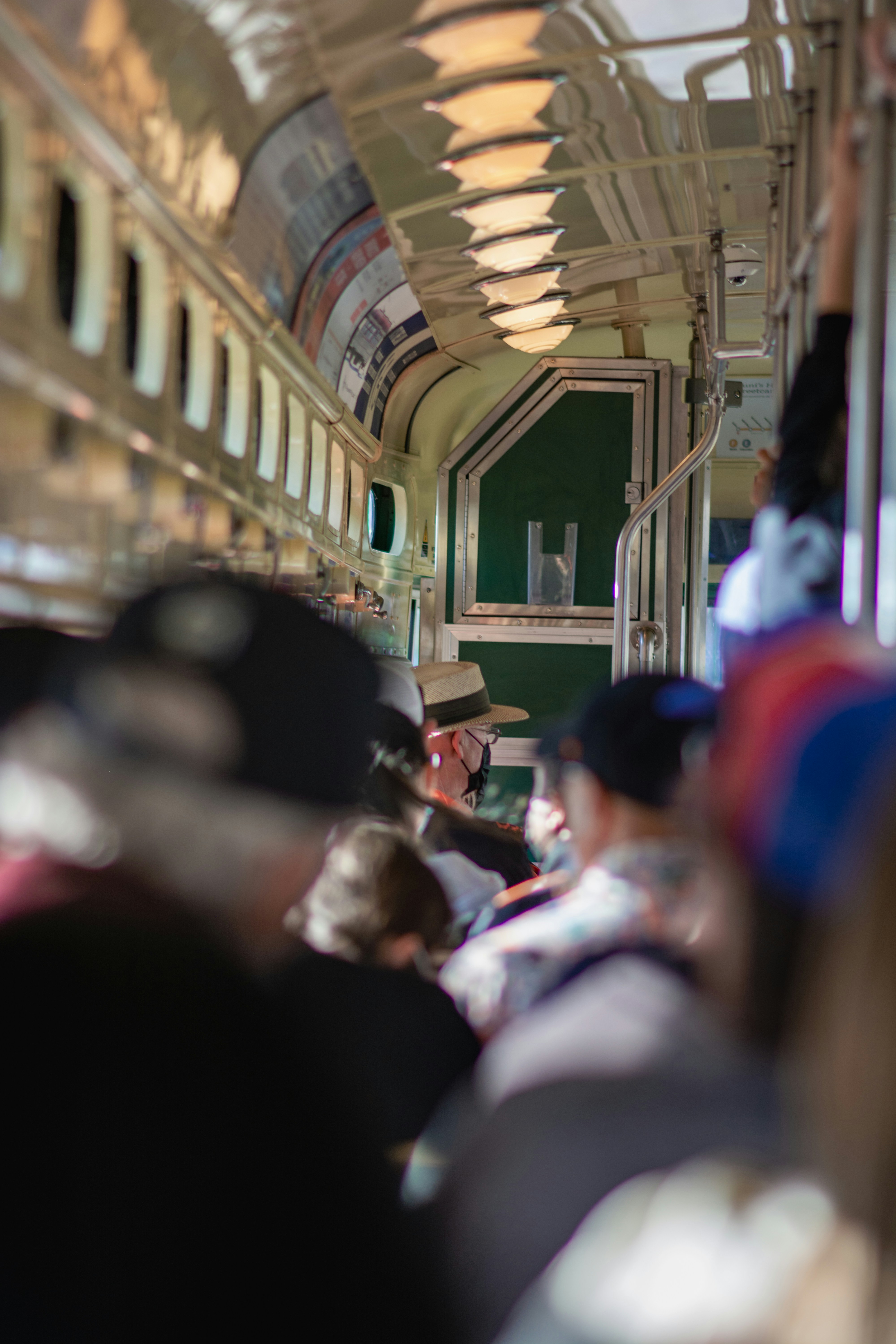 Green Door at the End of a Crowded Vintage Train Car