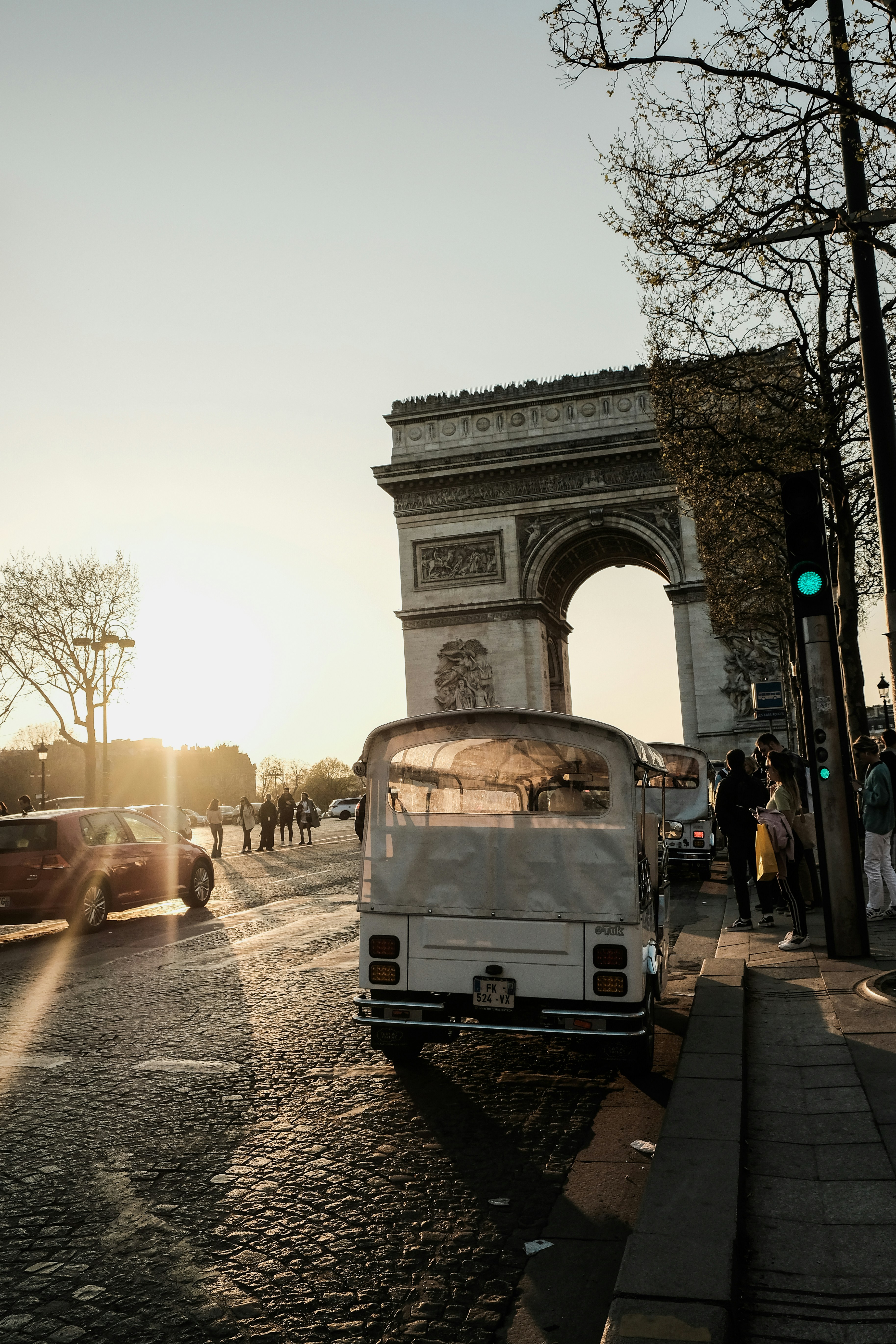 Golden Hour on the Cobblestones: A Vintage Bus by the Arc de Triomphe