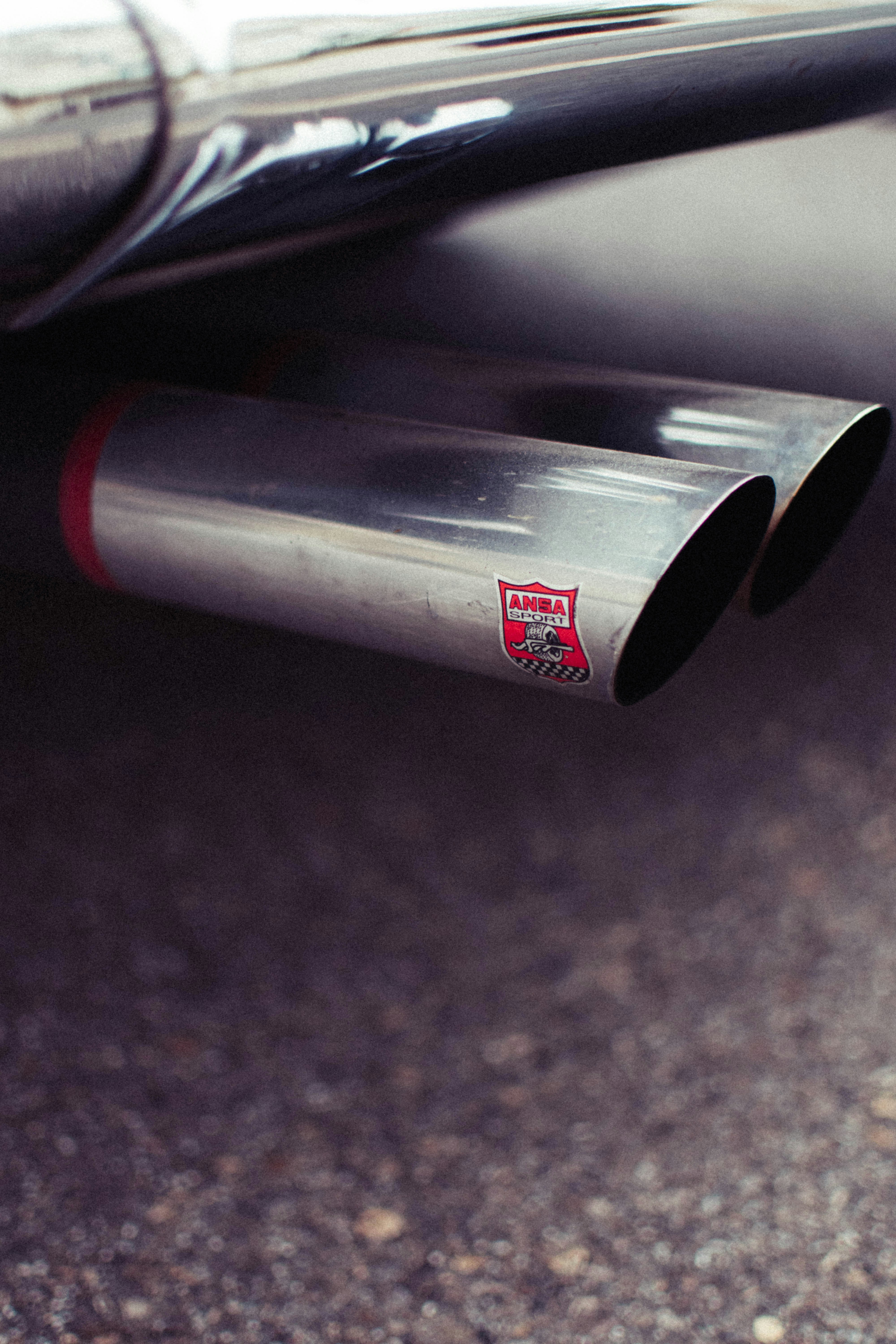 Dual Chrome Exhausts: Close-Up on a Red-Badge Detail