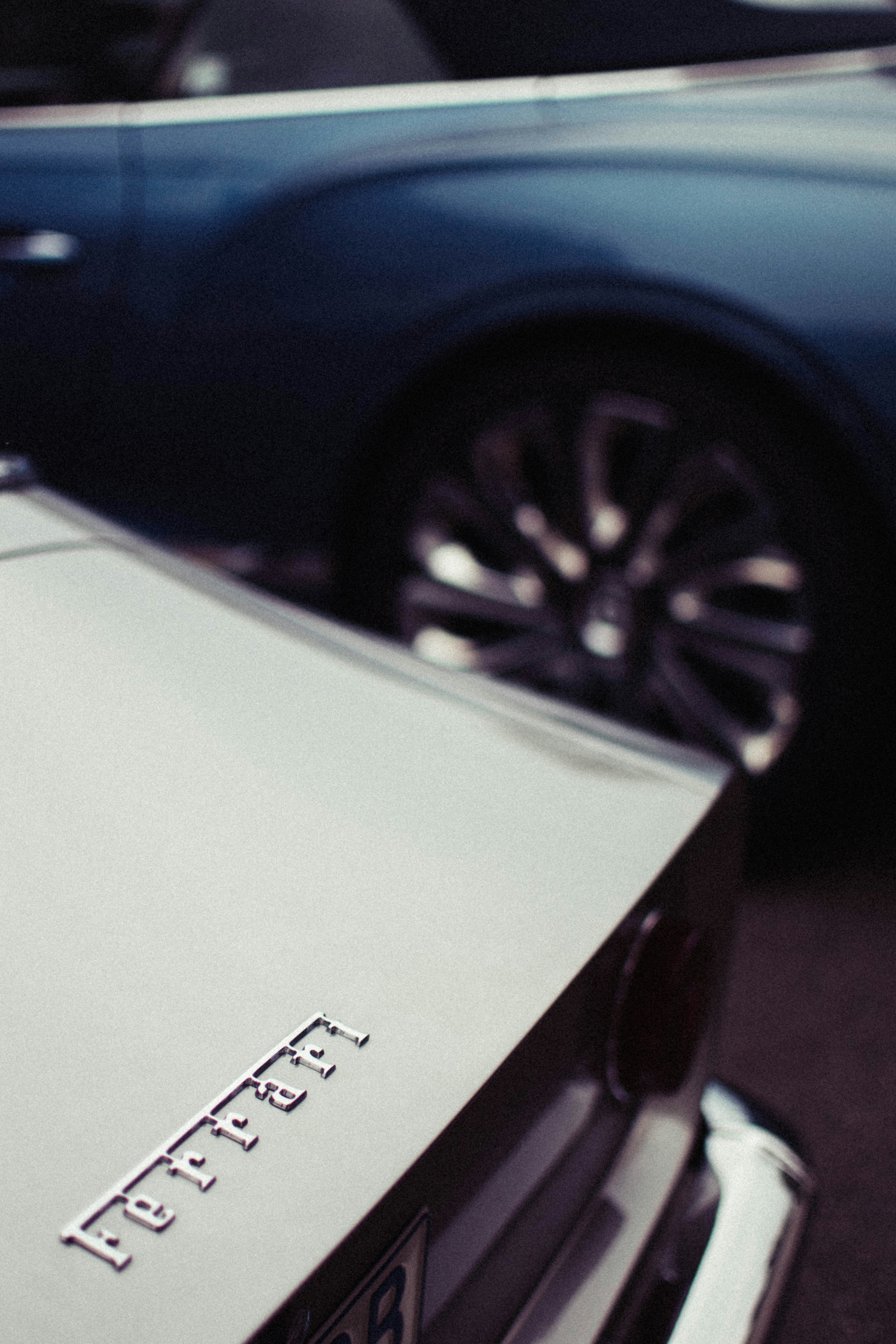 Chrome Crest on White Hood: Ferrari Emblem in Focus