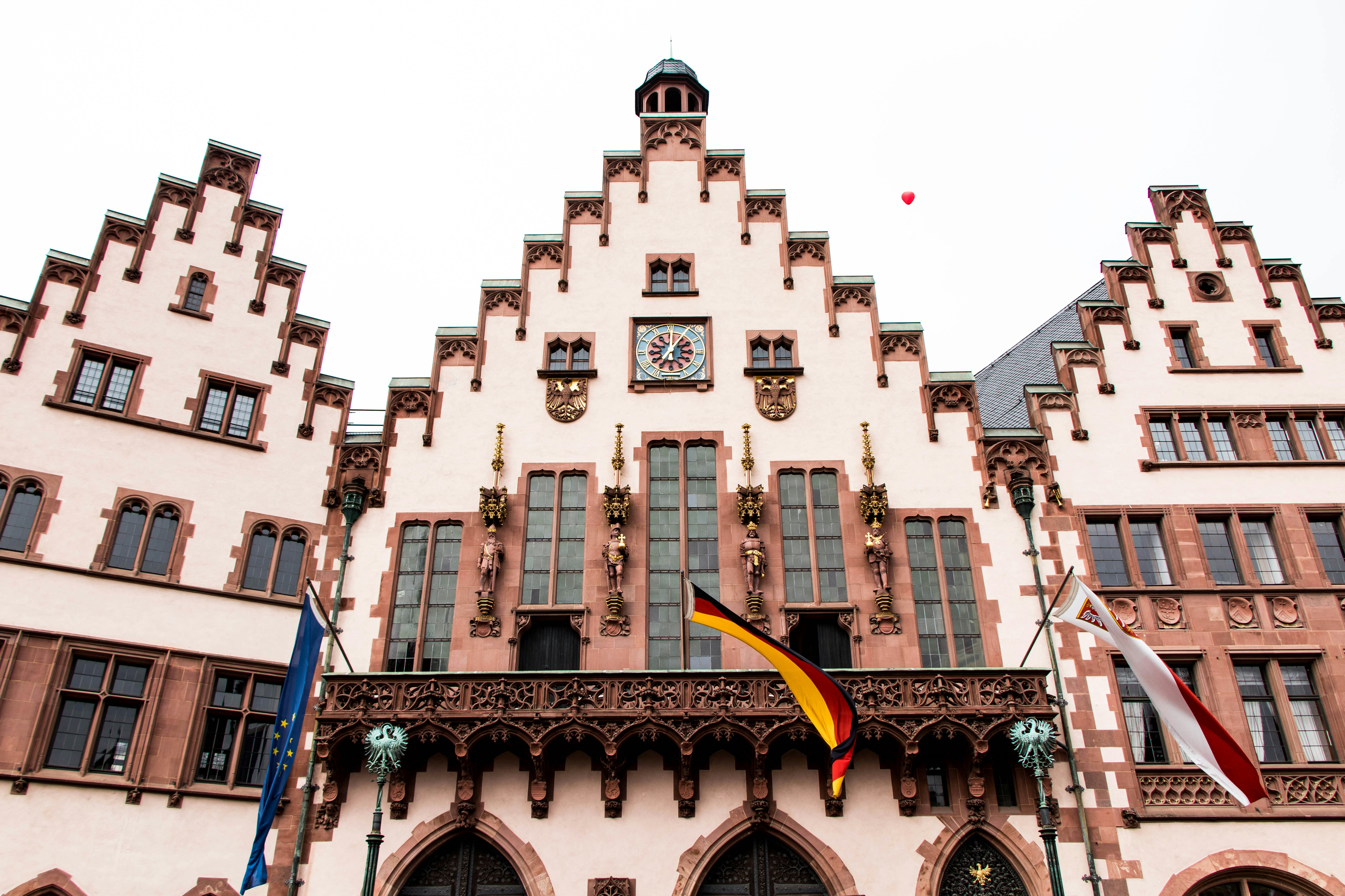 Gothic Facade Symmetry: Flags, Shields and a Crowning Clock
