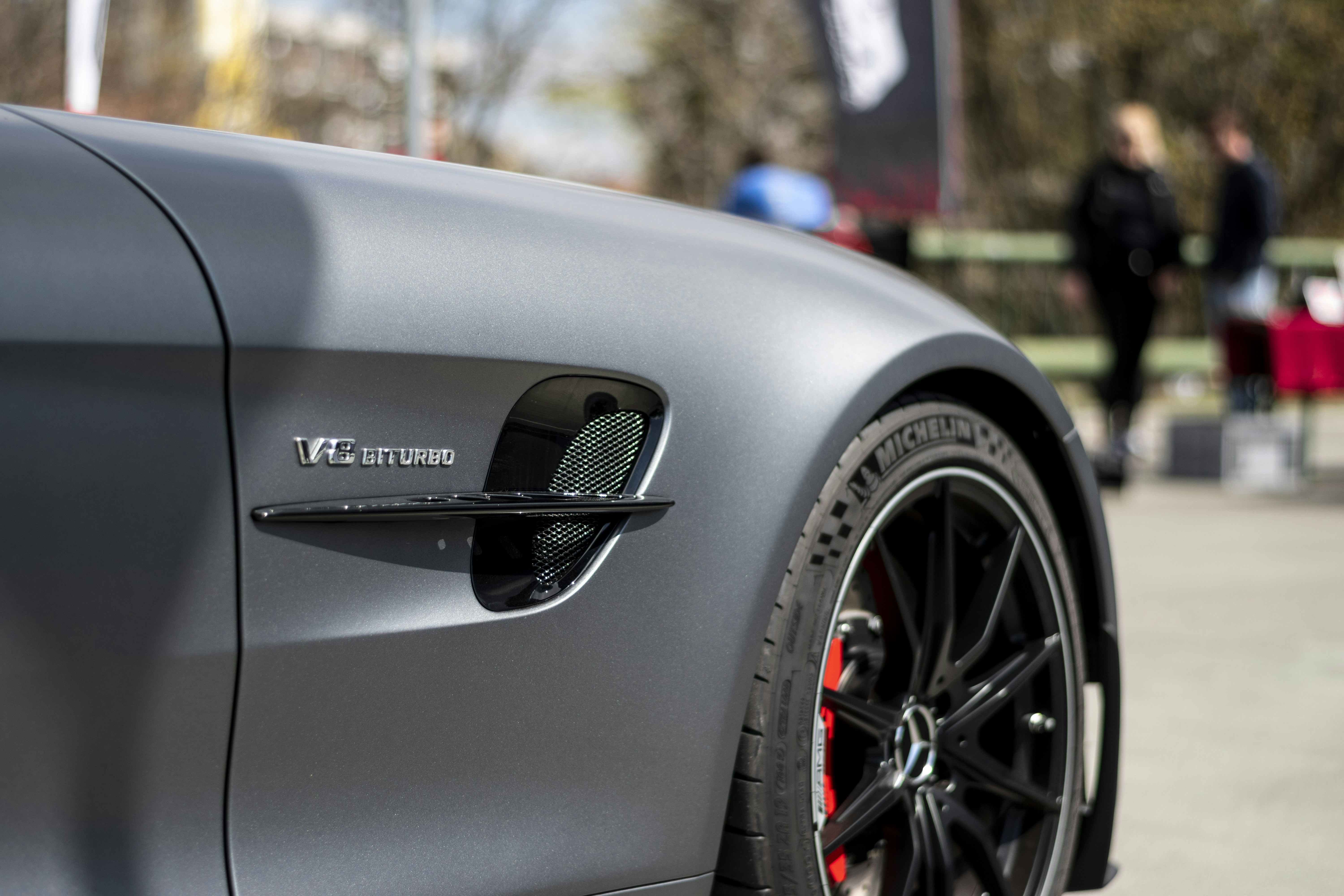 Matte AMG V8 BiTurbo badge gleams beside a dark alloy wheel