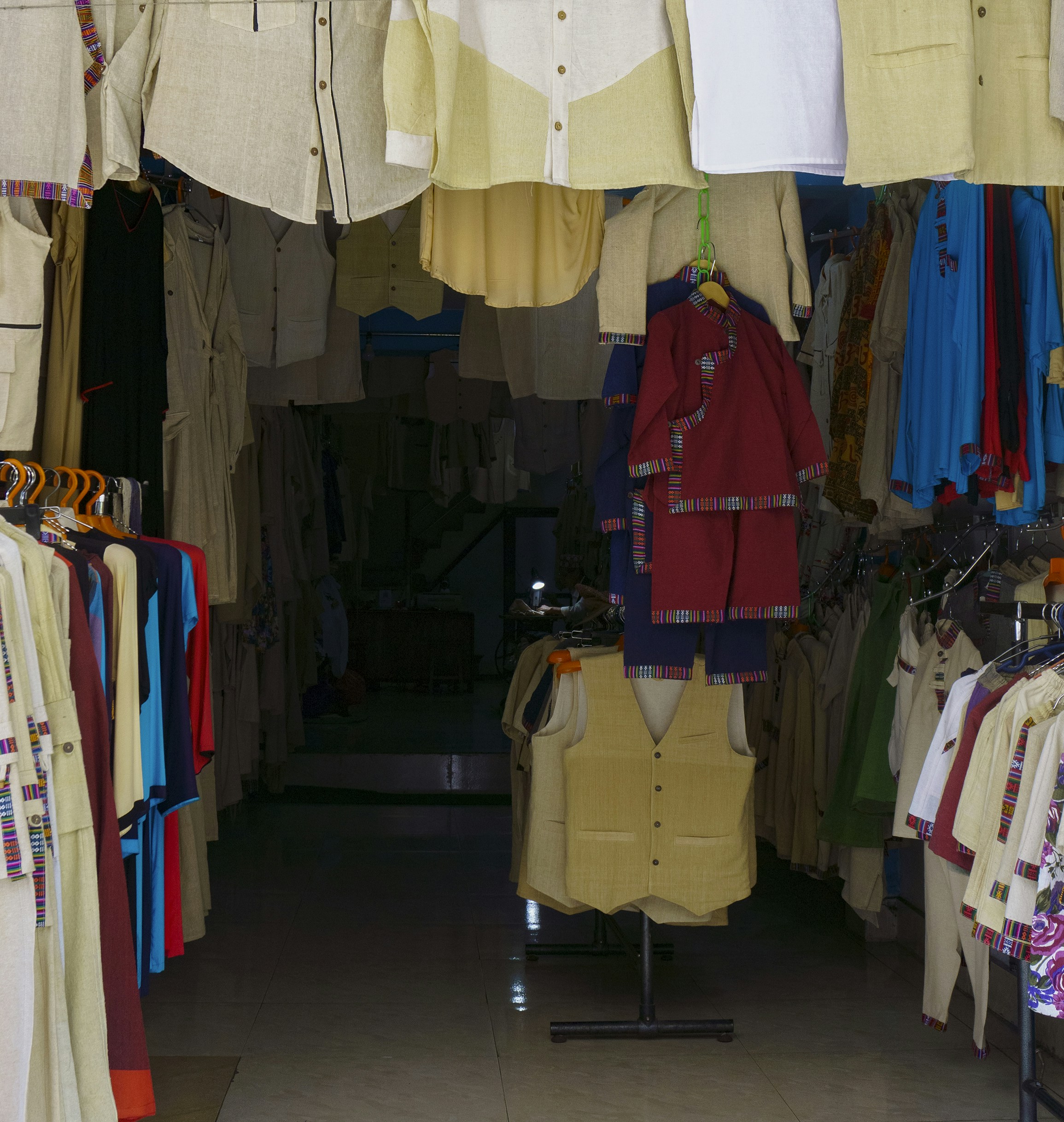 Boutique Wardrobe: A Corridor of Pastel Garments and Hanging Ensembles