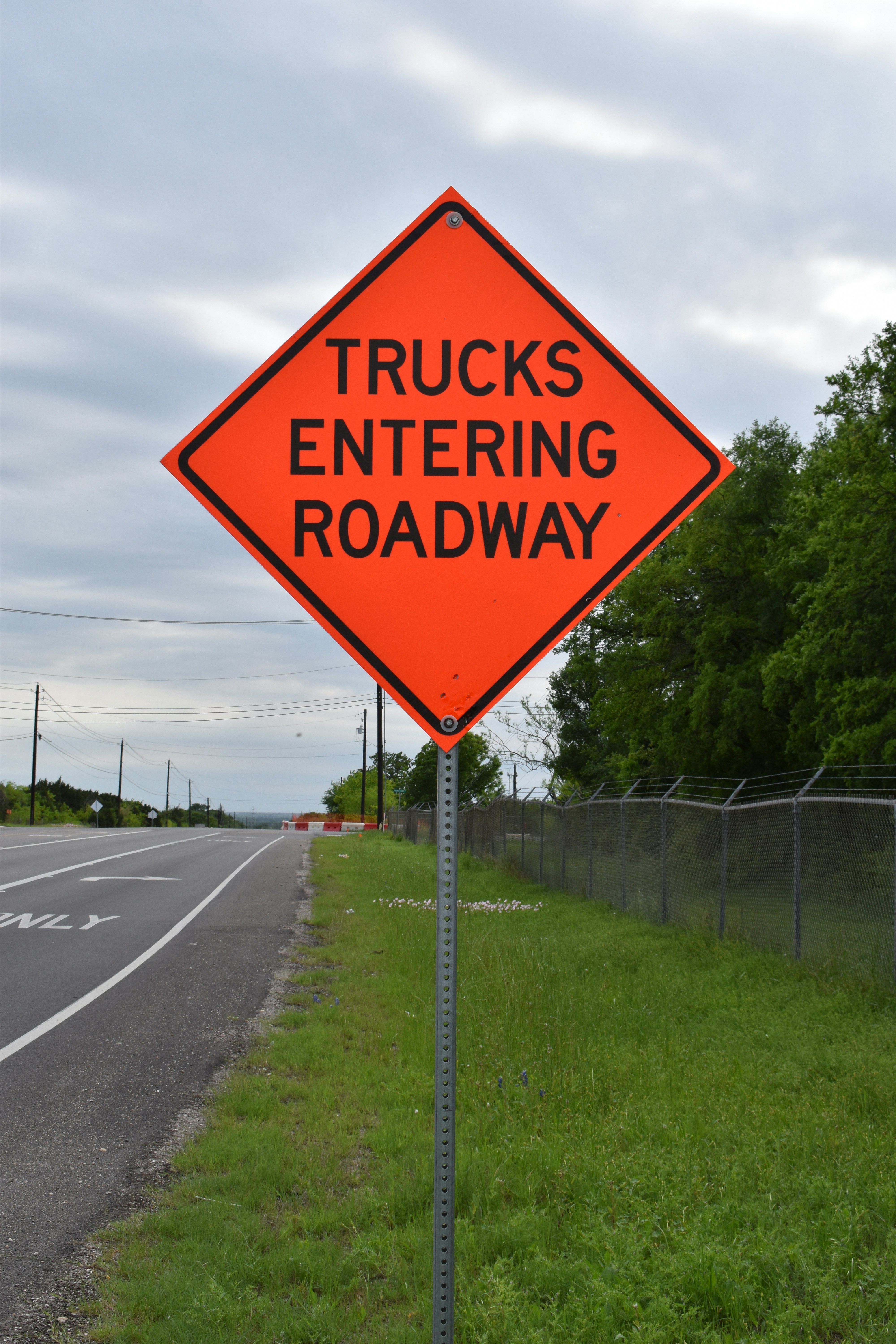 A truck entering road sign on the side of the road photo – Free Road ...