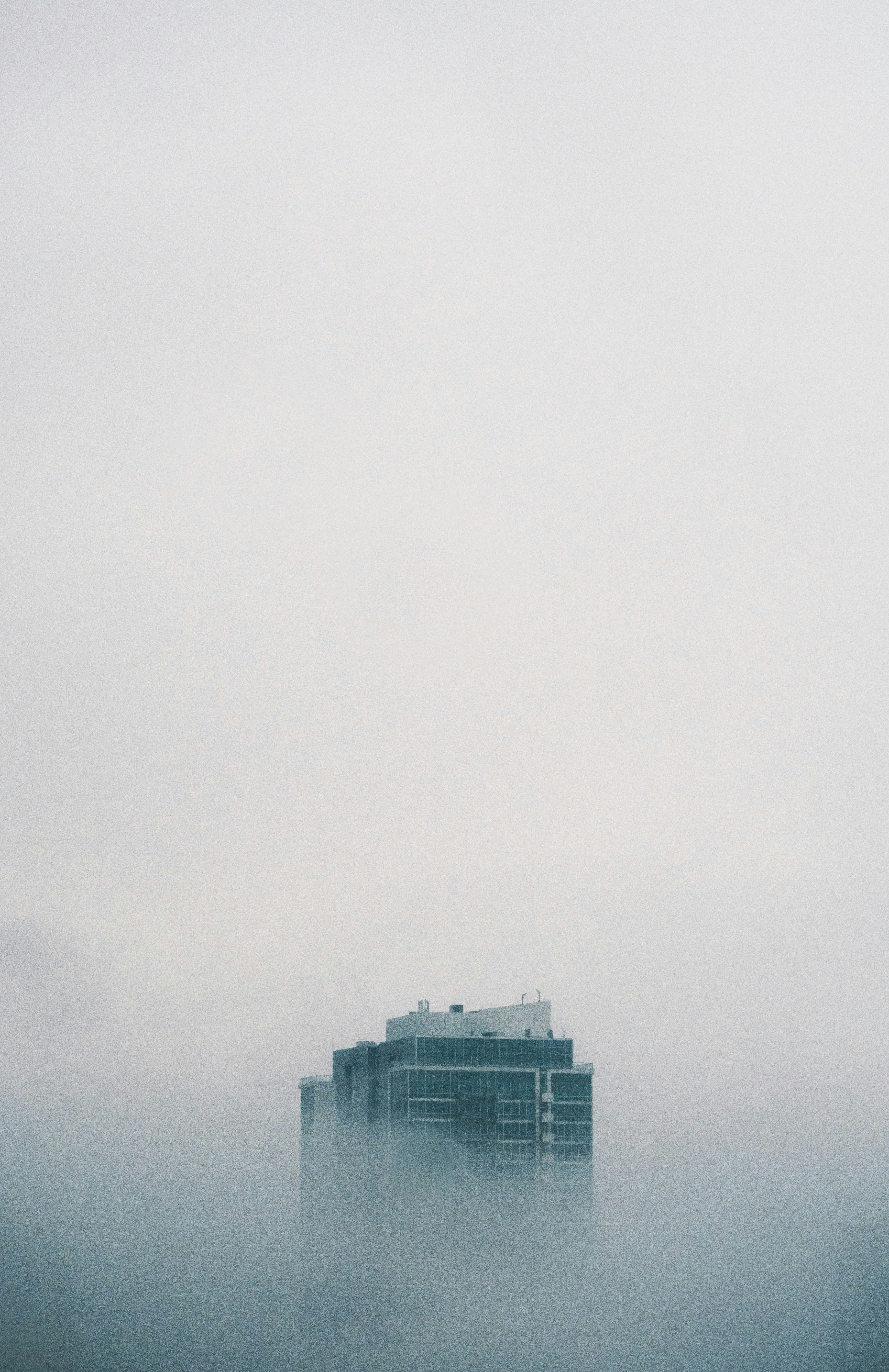 A building in the middle of a foggy city photo – Free Chicago Image on ...