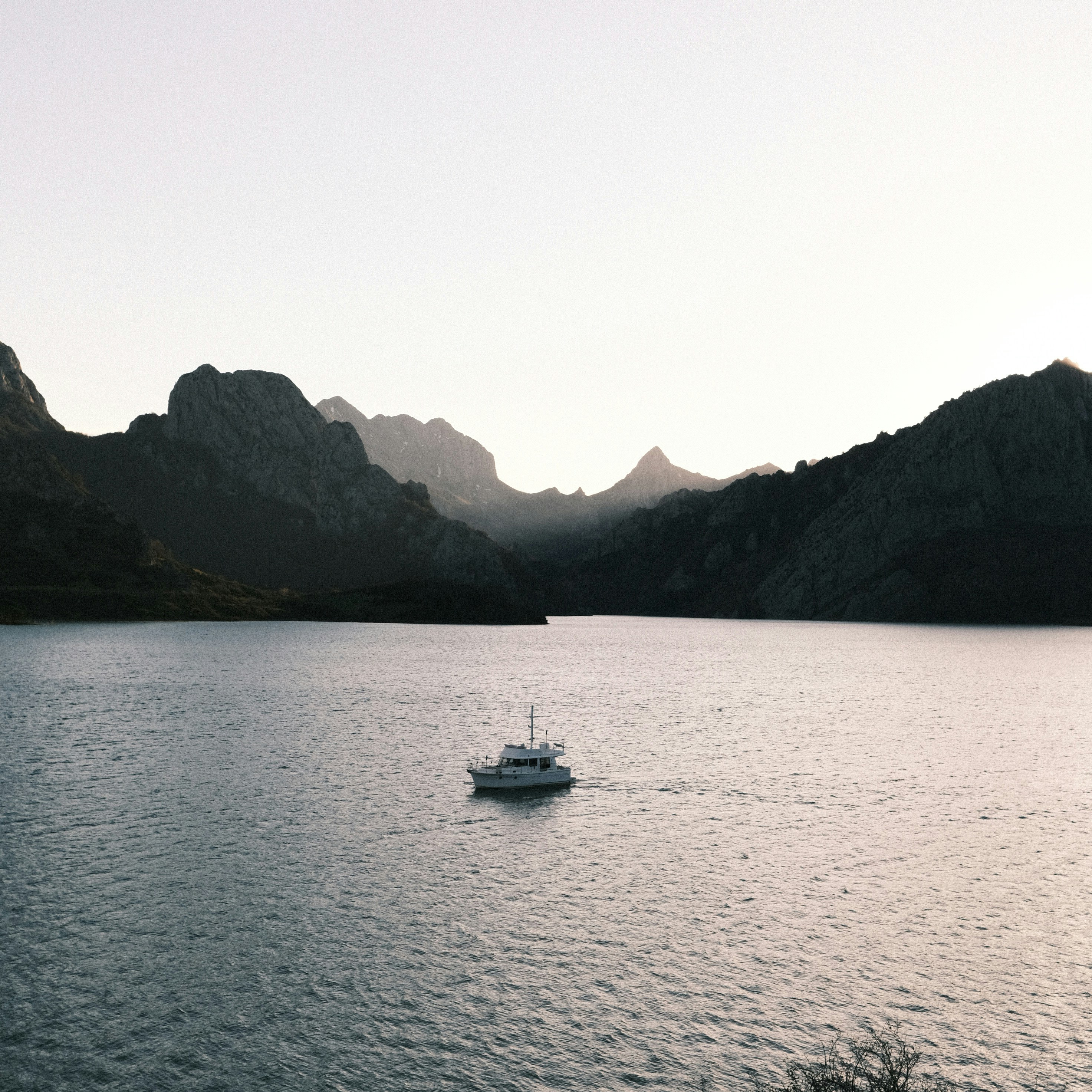 Lone Vessel on a Mountain Fjord at Dusk