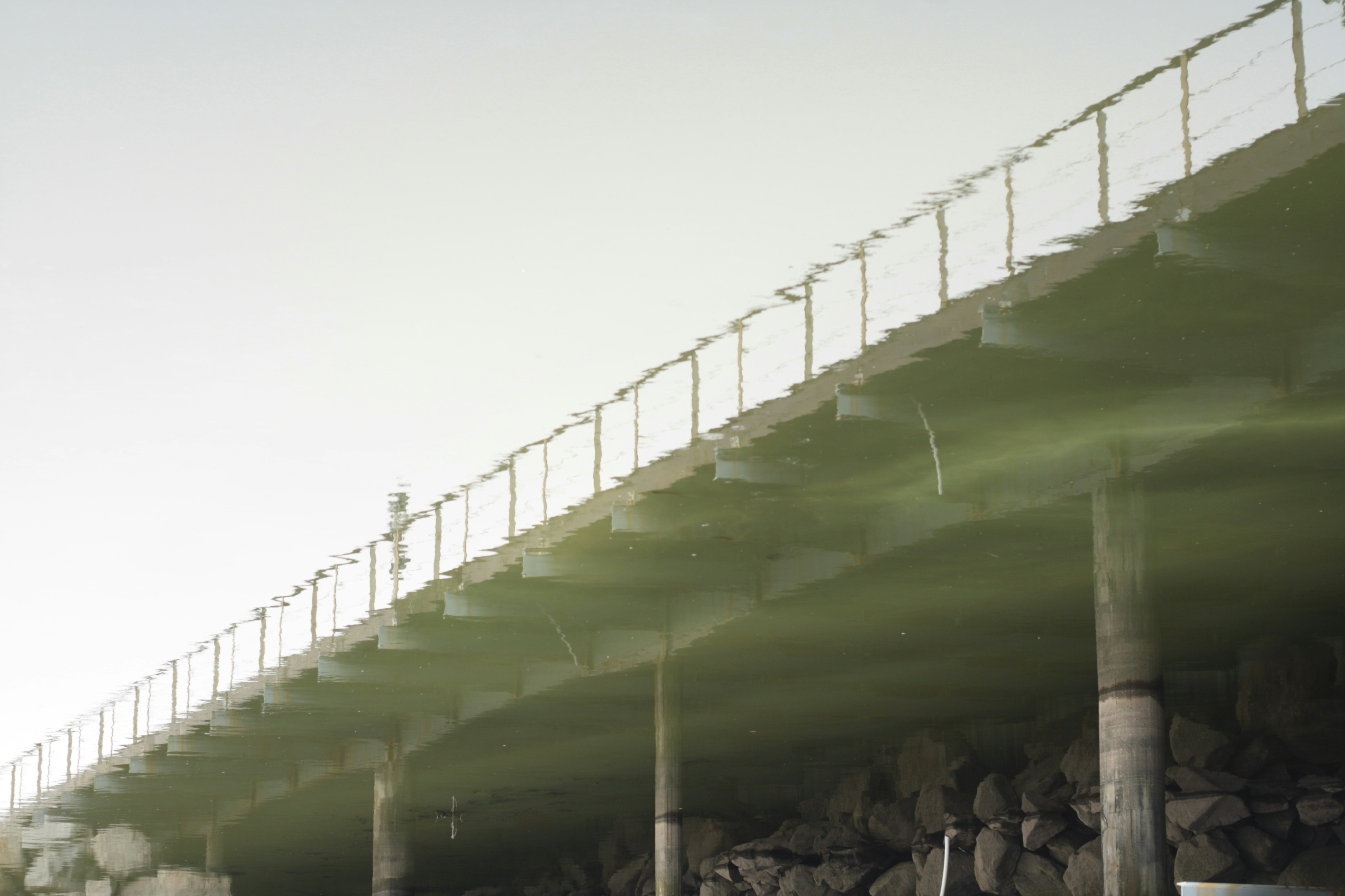 Edge Span: Railing and Pillars Over a Quiet Quarry