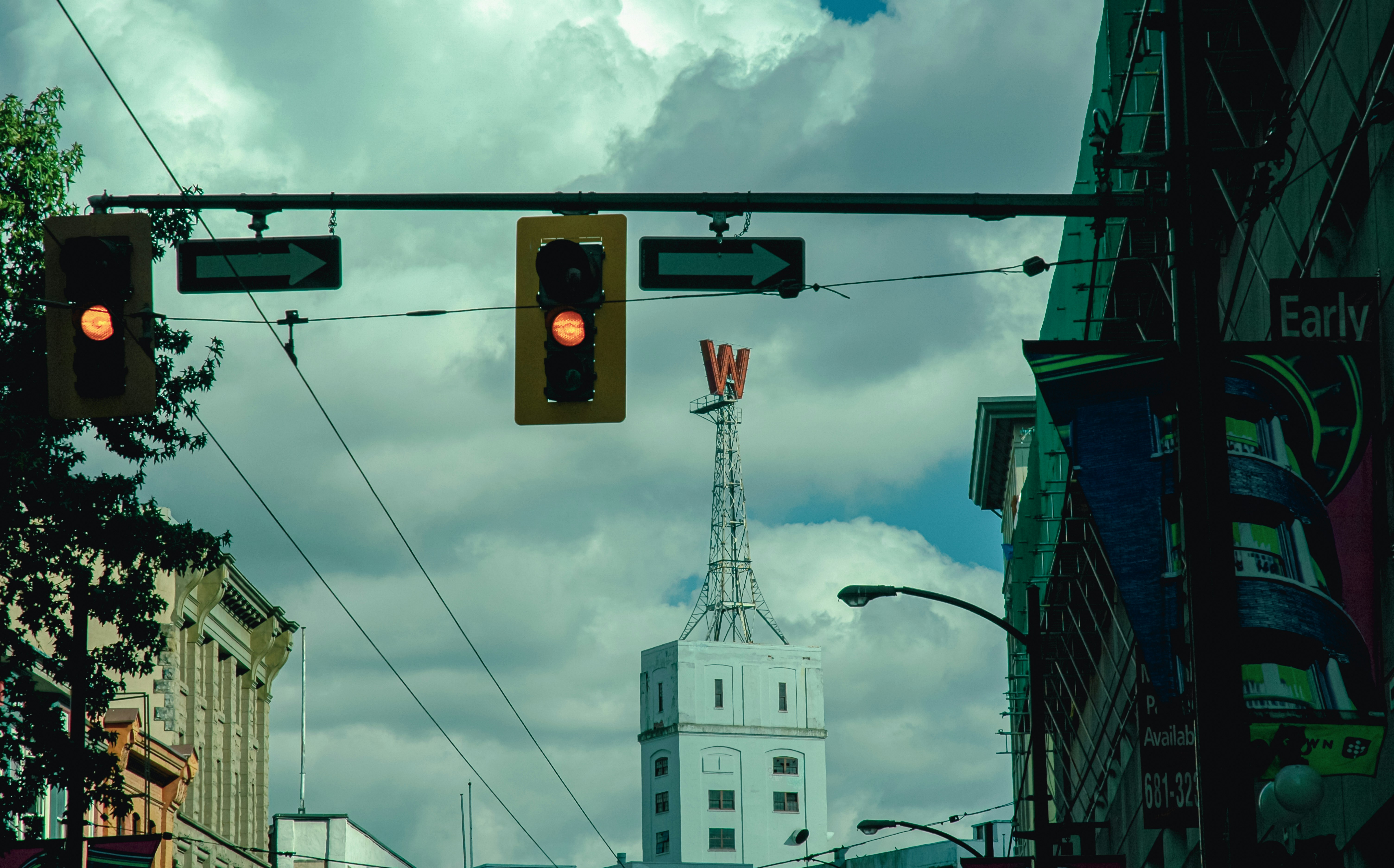 A traffic light hanging over a city street photo – Free Traffic light ...