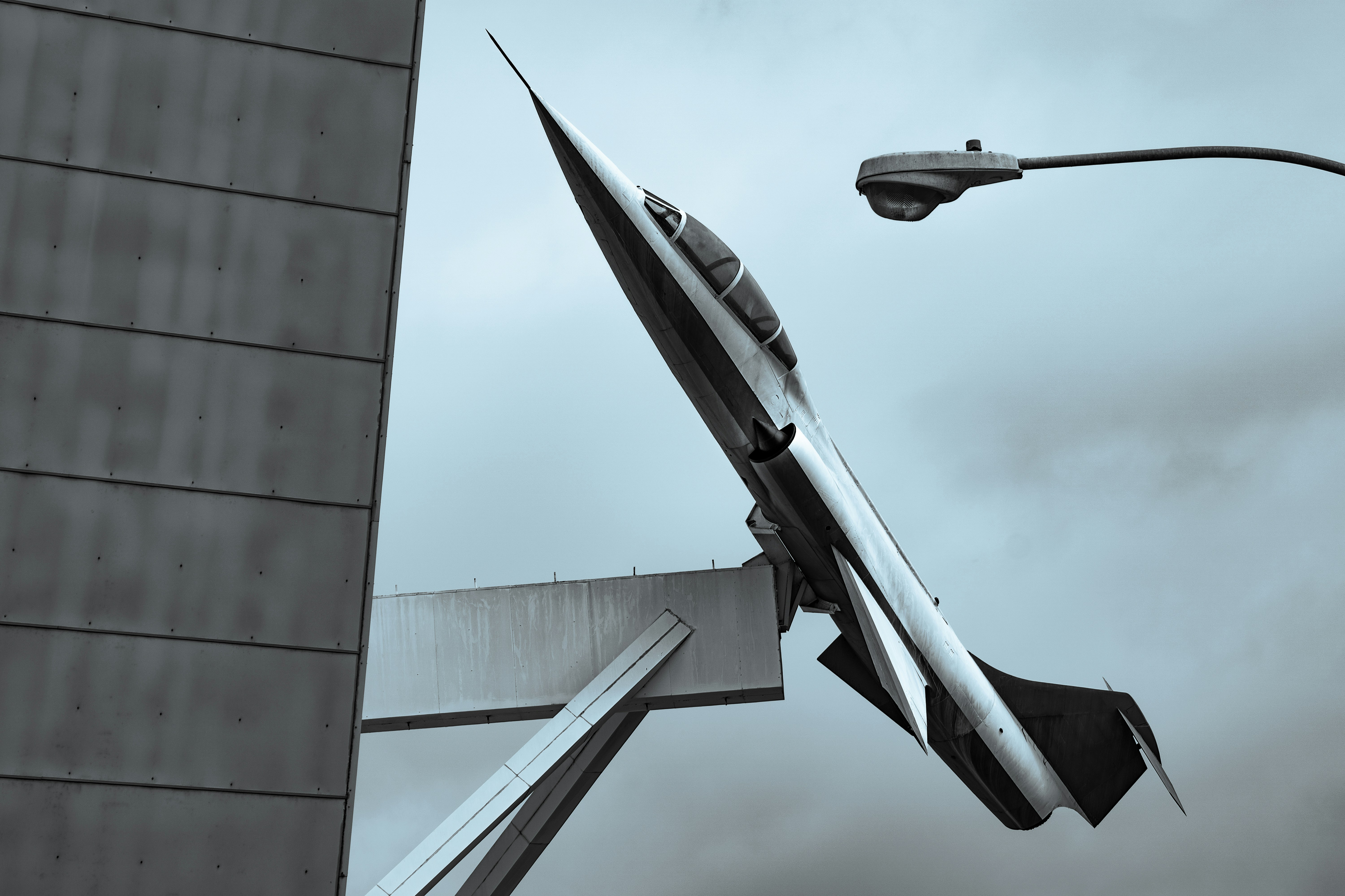Urban Lift-off: A Sleek Jet-Bridge Probe Against a Stormy Sky