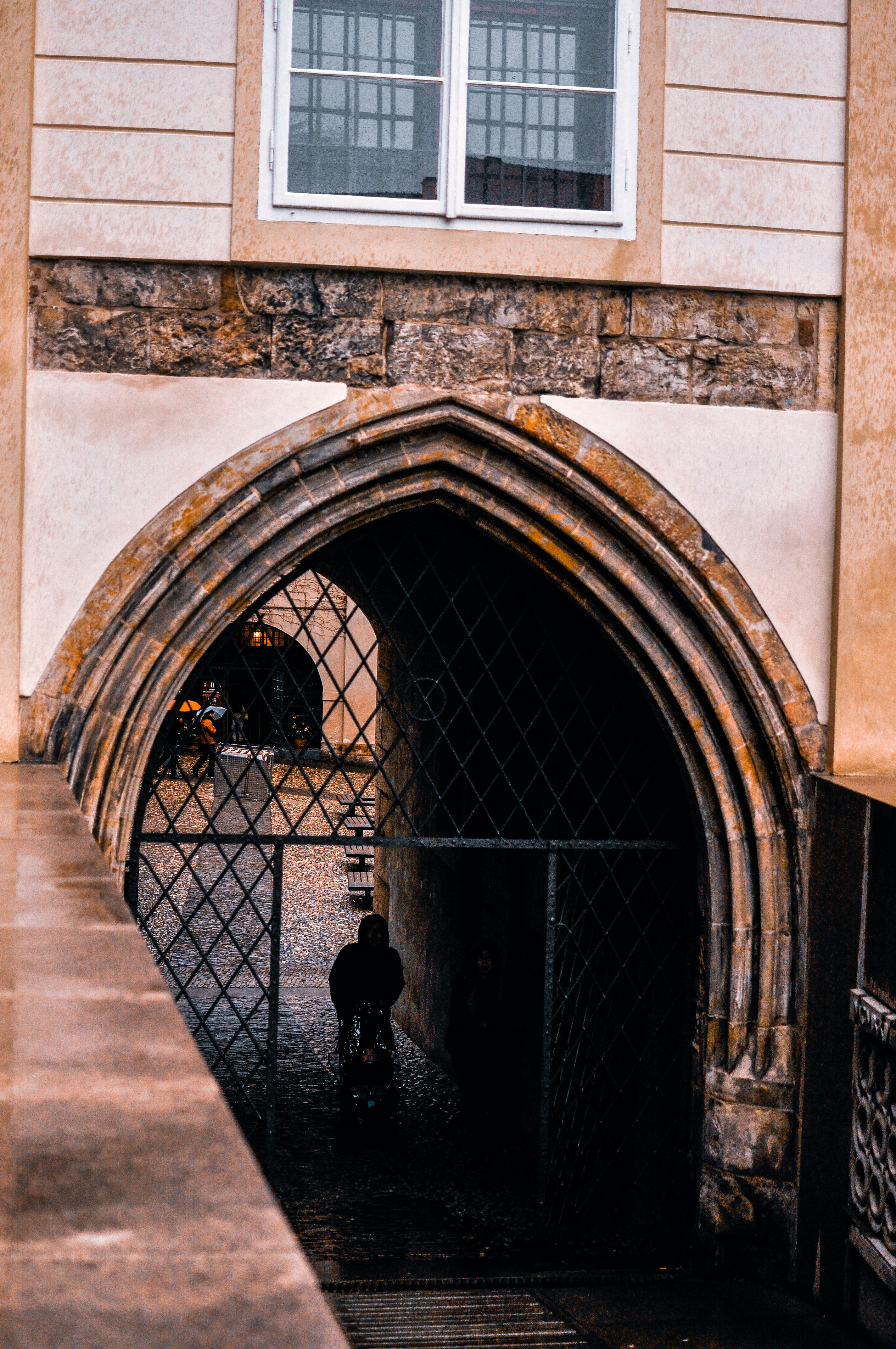 Through the Arch: A Narrow Path Beneath Ancient Stone