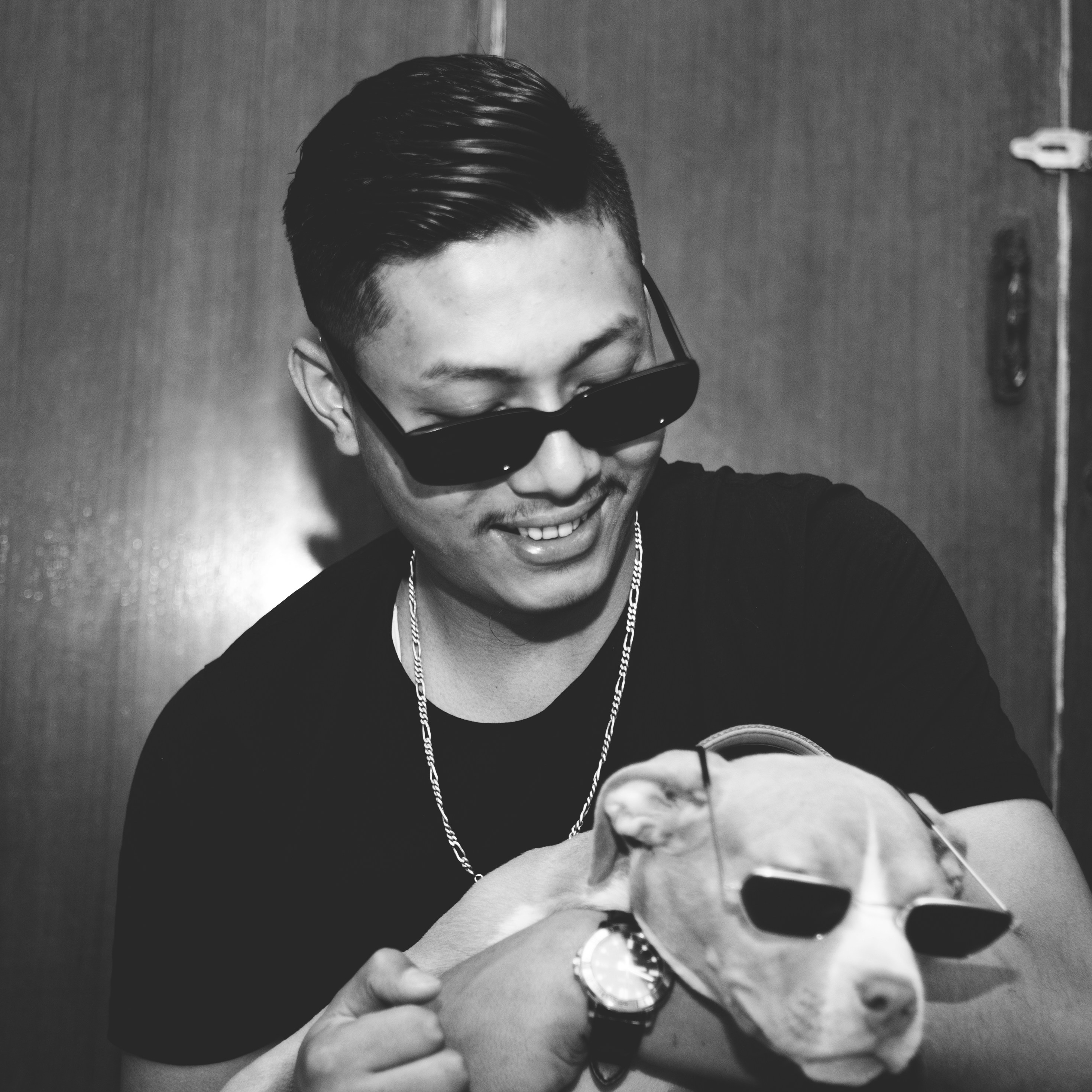 Smiles in Sunglasses: A Quiet Moment with a Muted Pup
