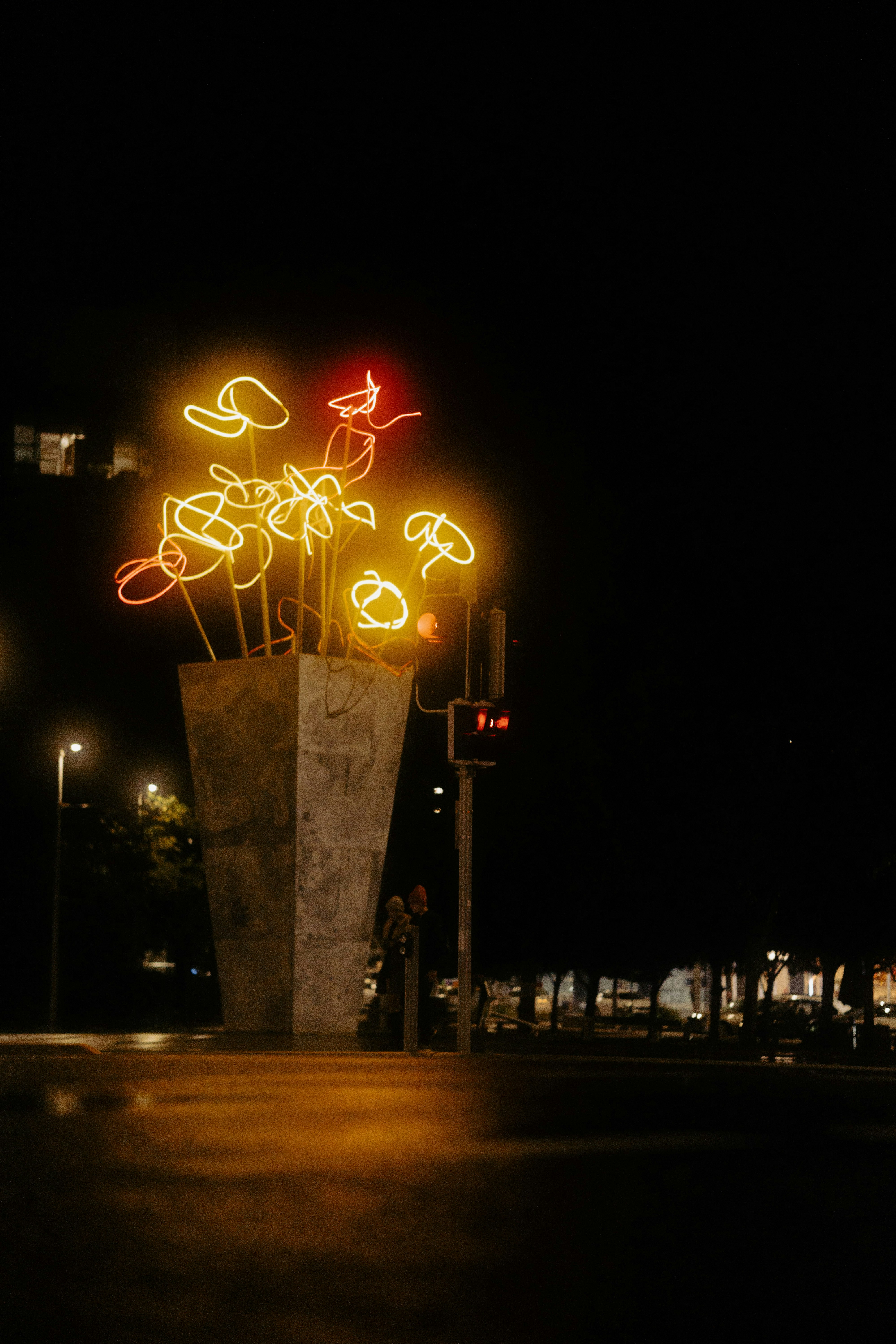 Neon Bloom: A Concrete Monument Blooms in Night Light