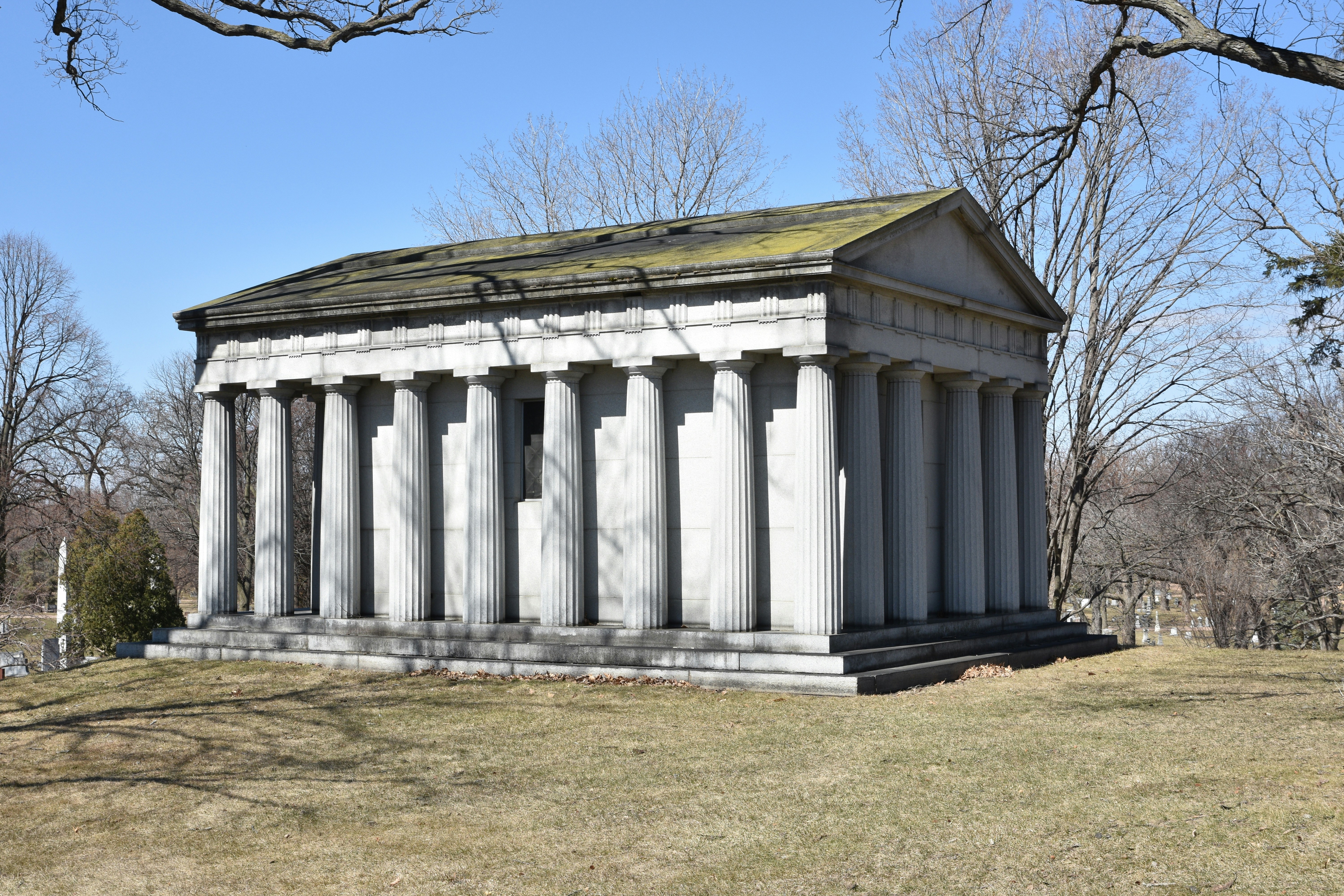 Sunlit Neoclassical Temple Framed by Winter Trees