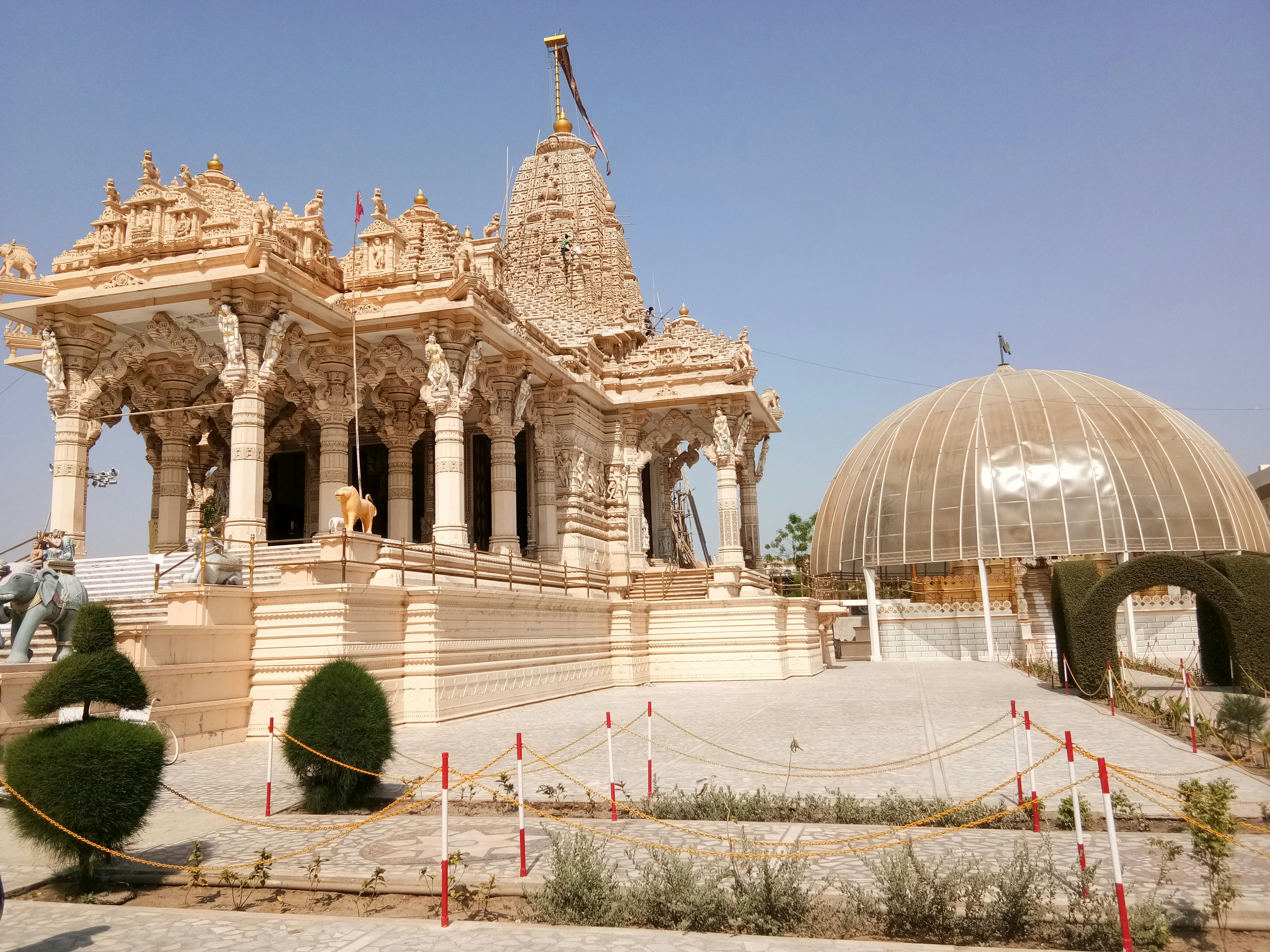 Awe the beauty of Shri Simandar Swami Jain Temple, Mehsana. | a large white building with a dome on top of it