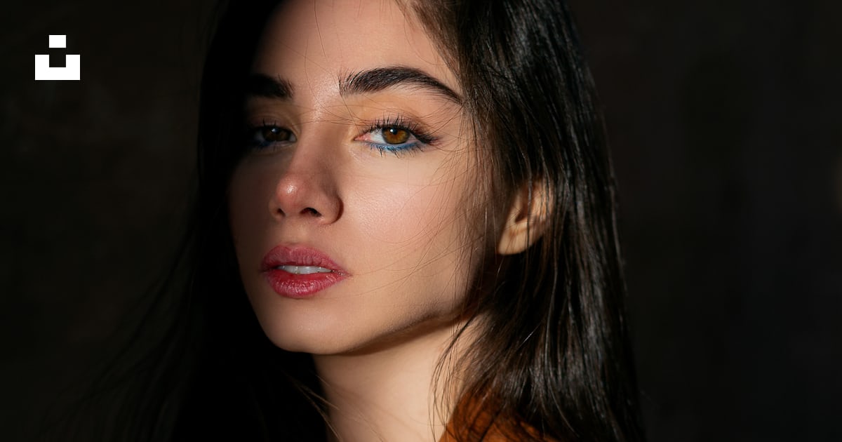 A Woman With Long Black Hair And Blue Eyes Photo Free Black Image On