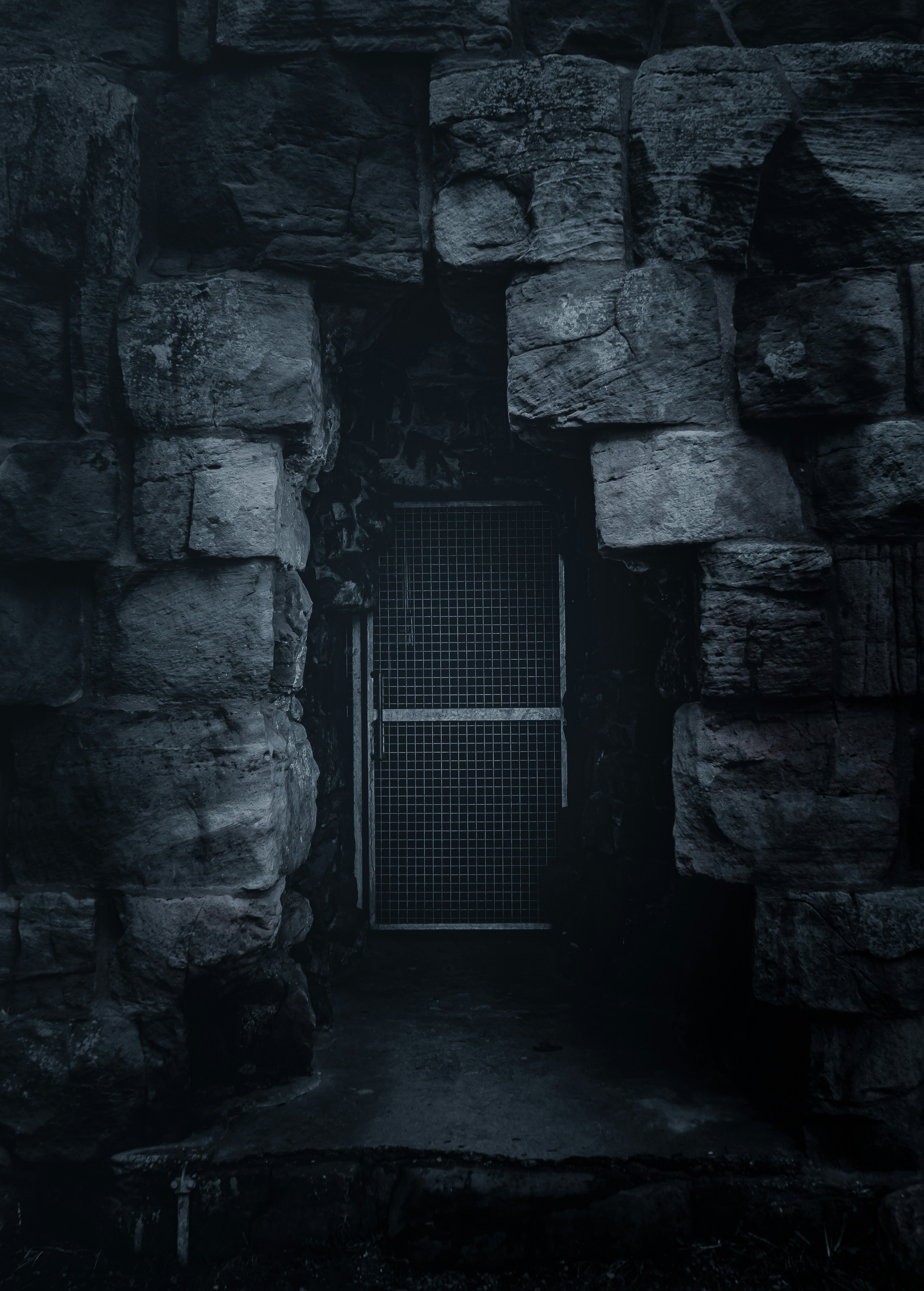 A jail cell door in a stone wall photo – Free Grey Image on Unsplash