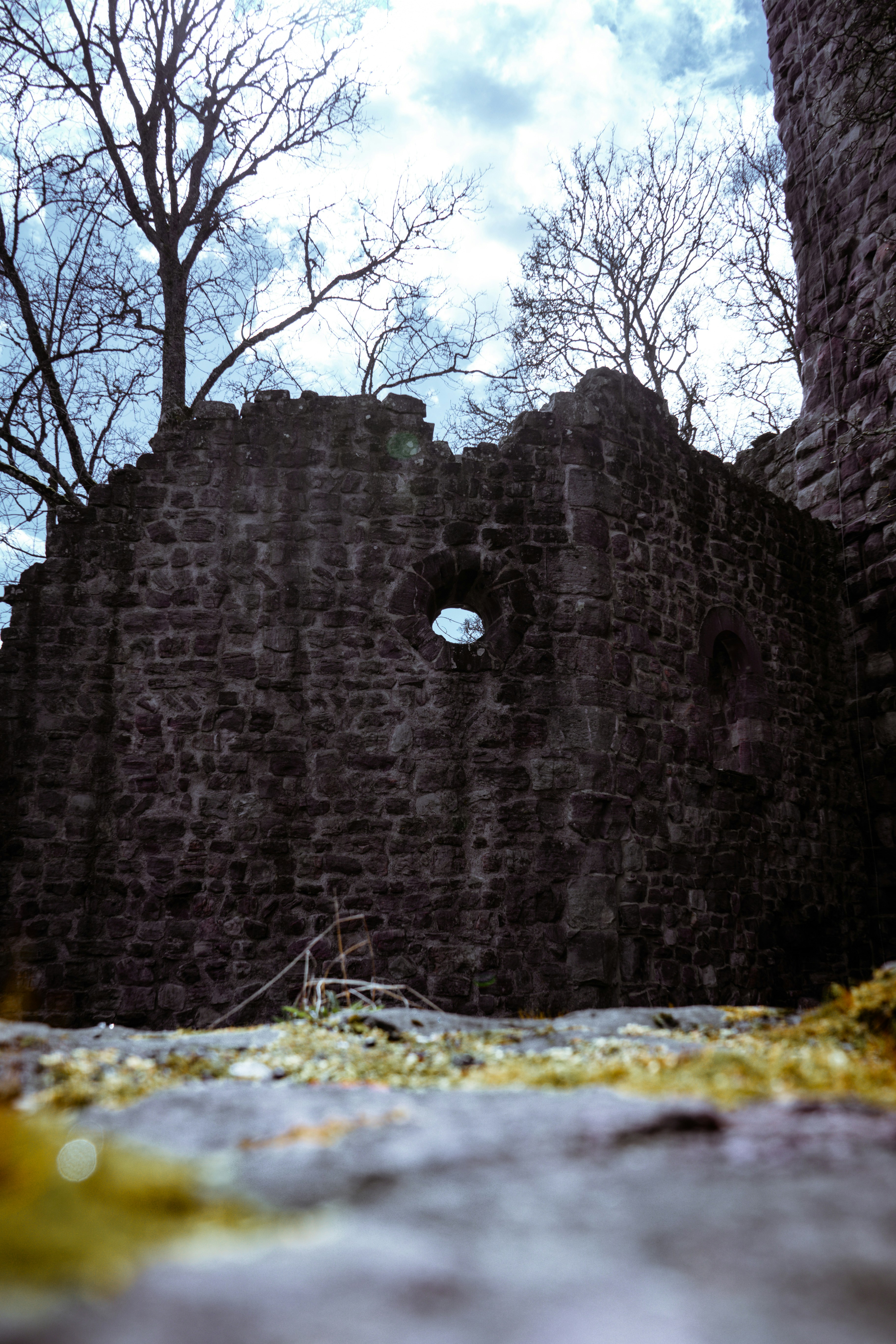a stone wall with a hole in the middle of it