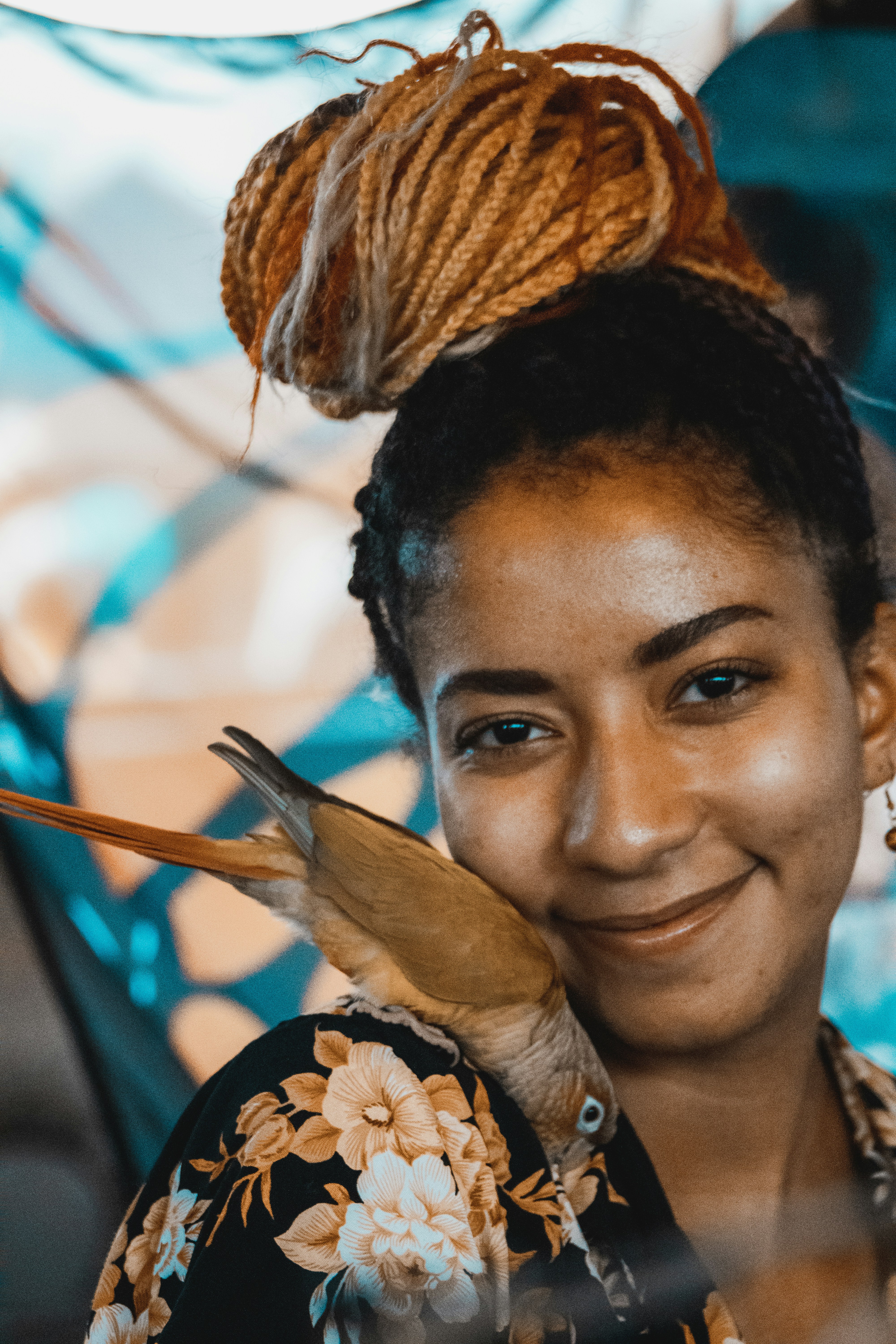 Urban Radiance: Dreadlocks, Floral Wear, and a Bird on the Shoulder