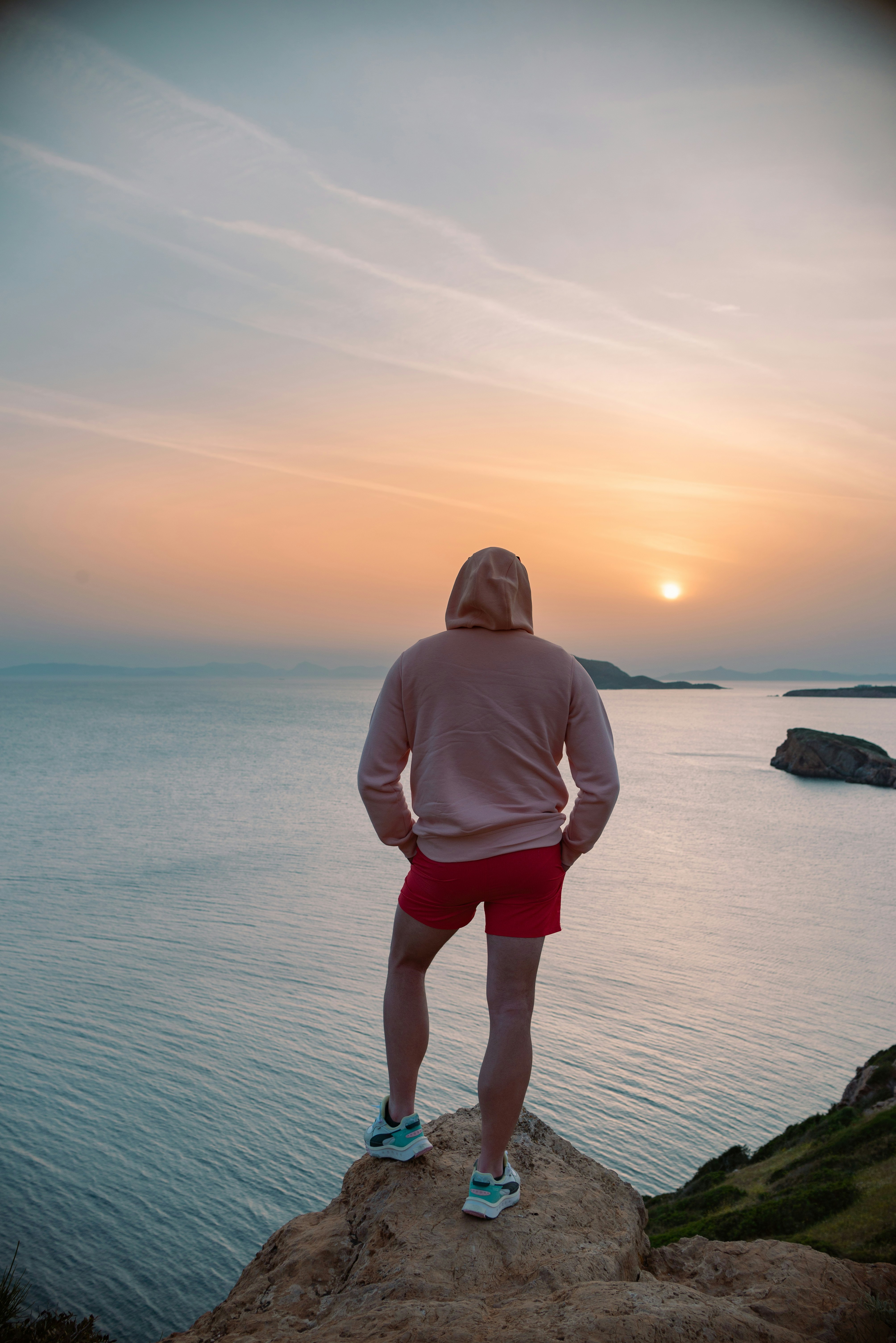 Sunset Sentinel on the Cliff: A lone figure gazes toward the horizon.