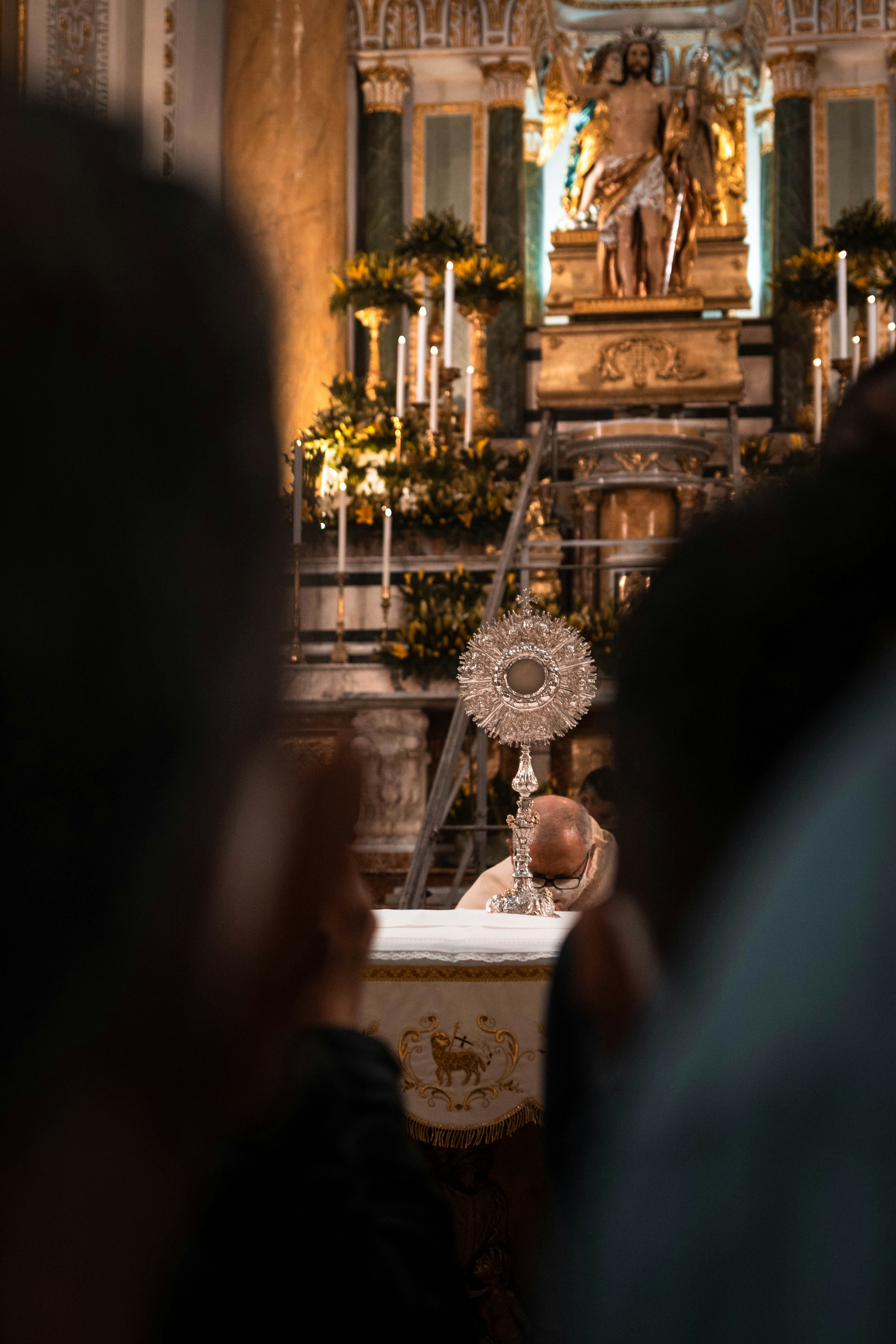A church with a statue of a person holding a parasol photo – Free ...