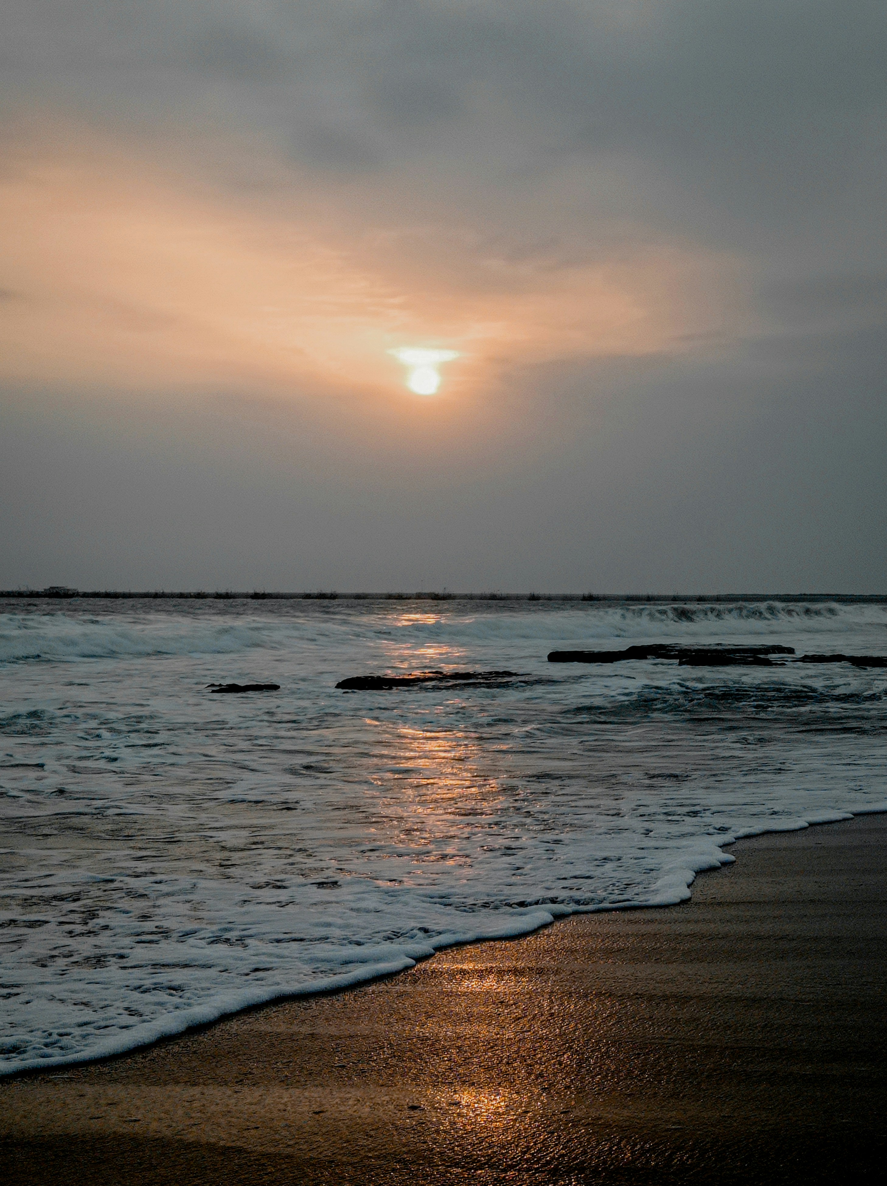 The sun is setting over the water at the beach photo – Free India Image ...