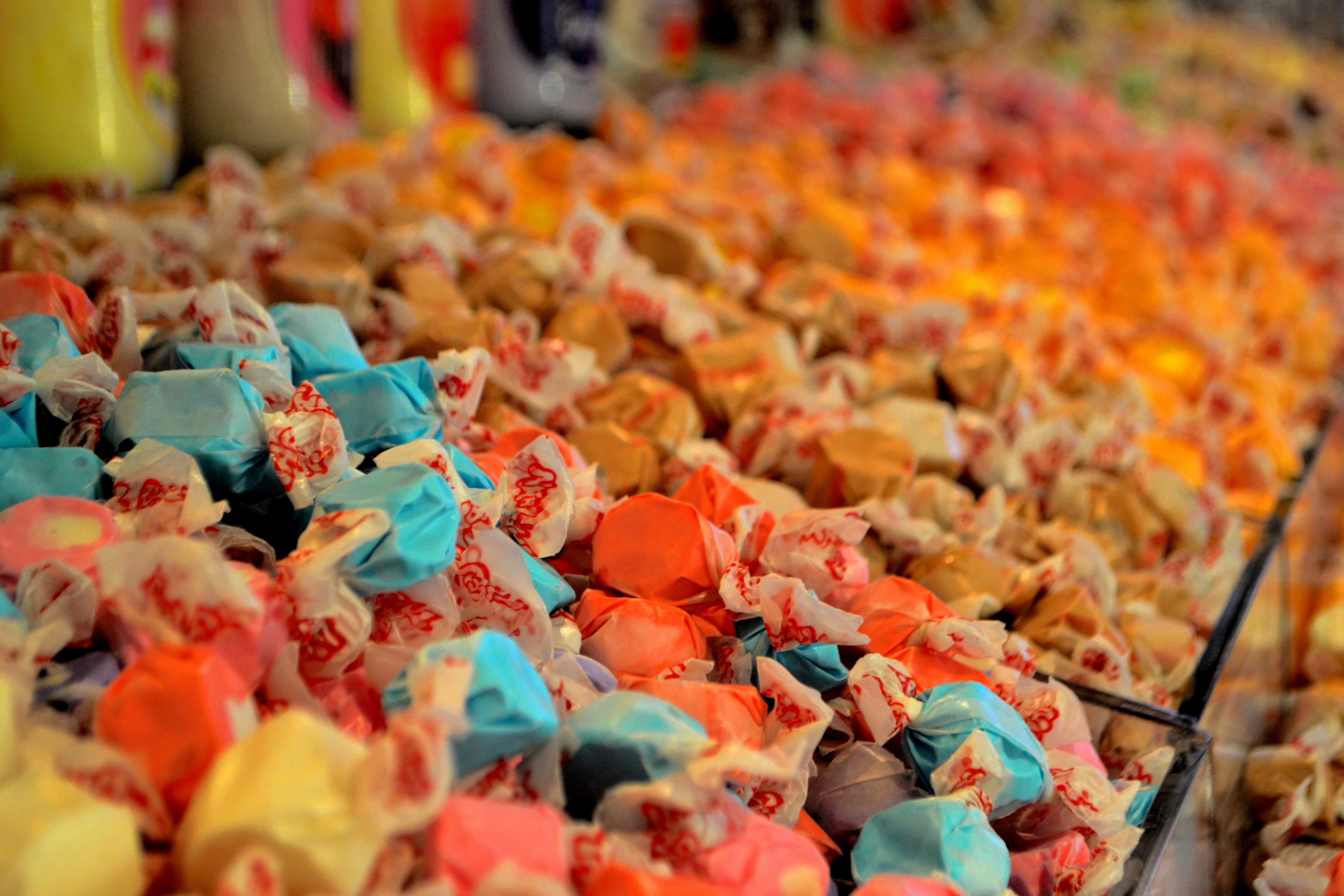 A display case filled with lots of different colored candies photo ...