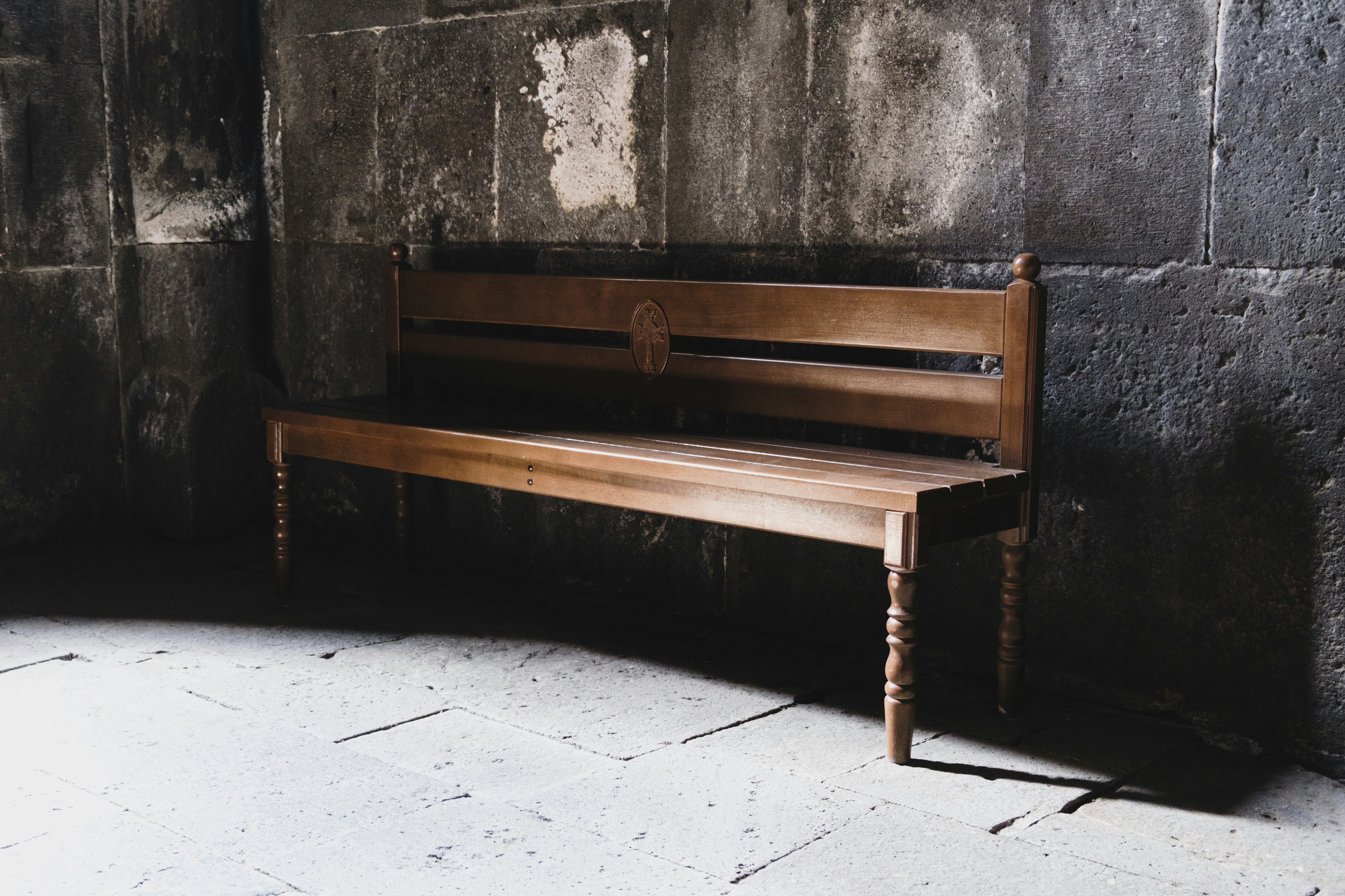 Lonely Wooden Bench in a Shadowed Industrial Space