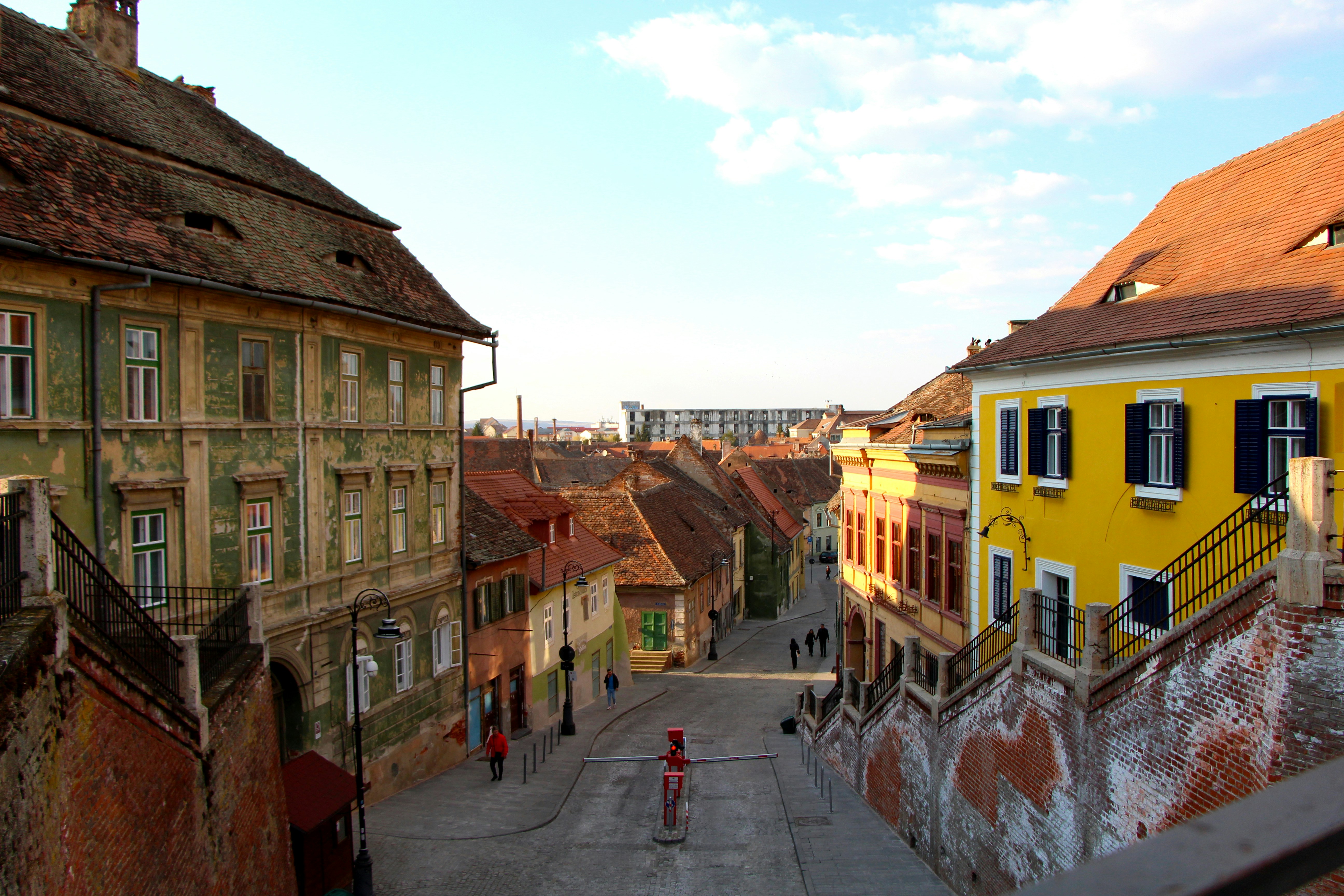the city stll sleeps, the old town in contrast with newer buildings in the back | a city street with buildings and a fire hydrant