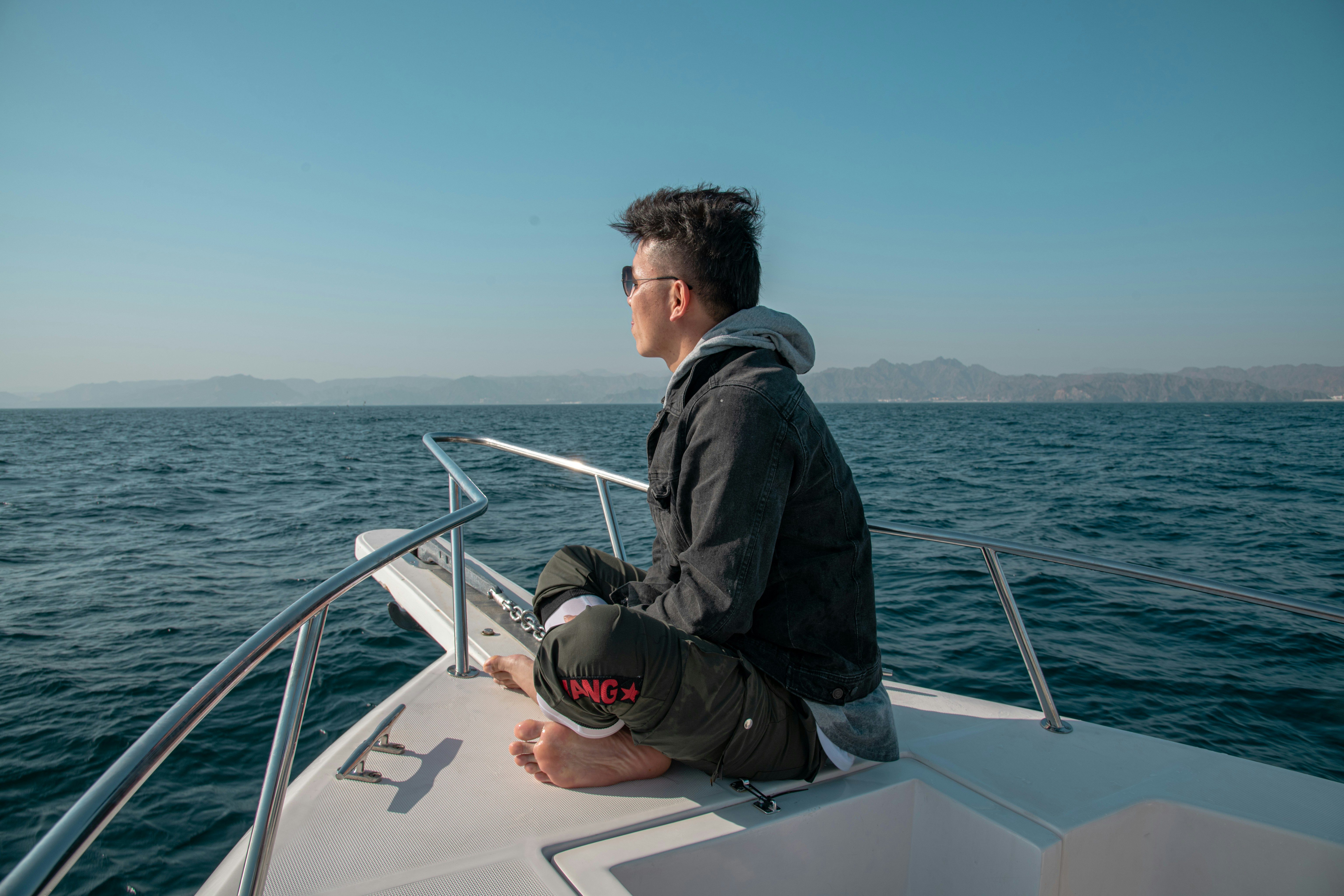Seated Voyager: A Quiet Moment Aboard at Sea