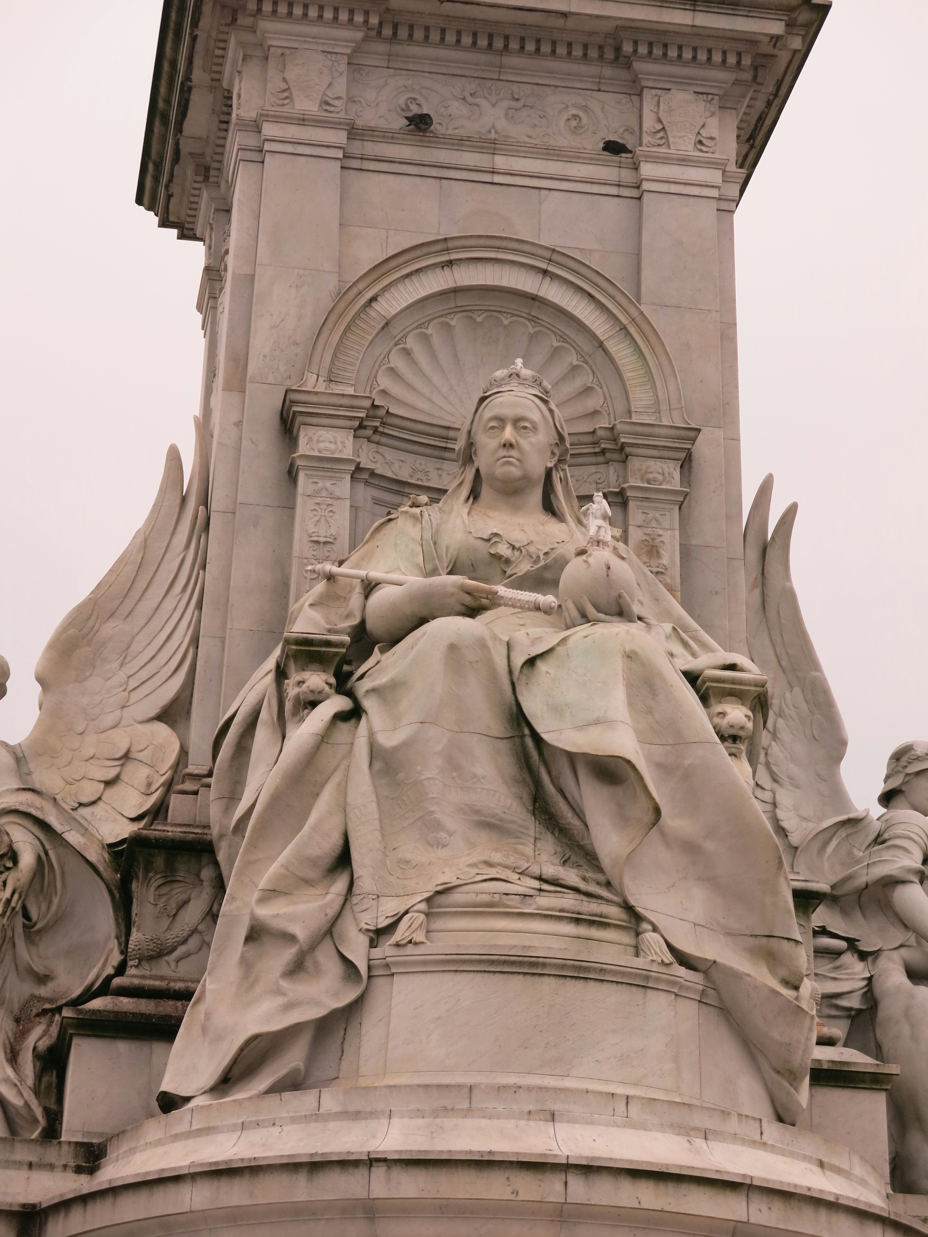 Empress on a Winged Pedestal: Seated Marble Monument Under Angelic Carvings
