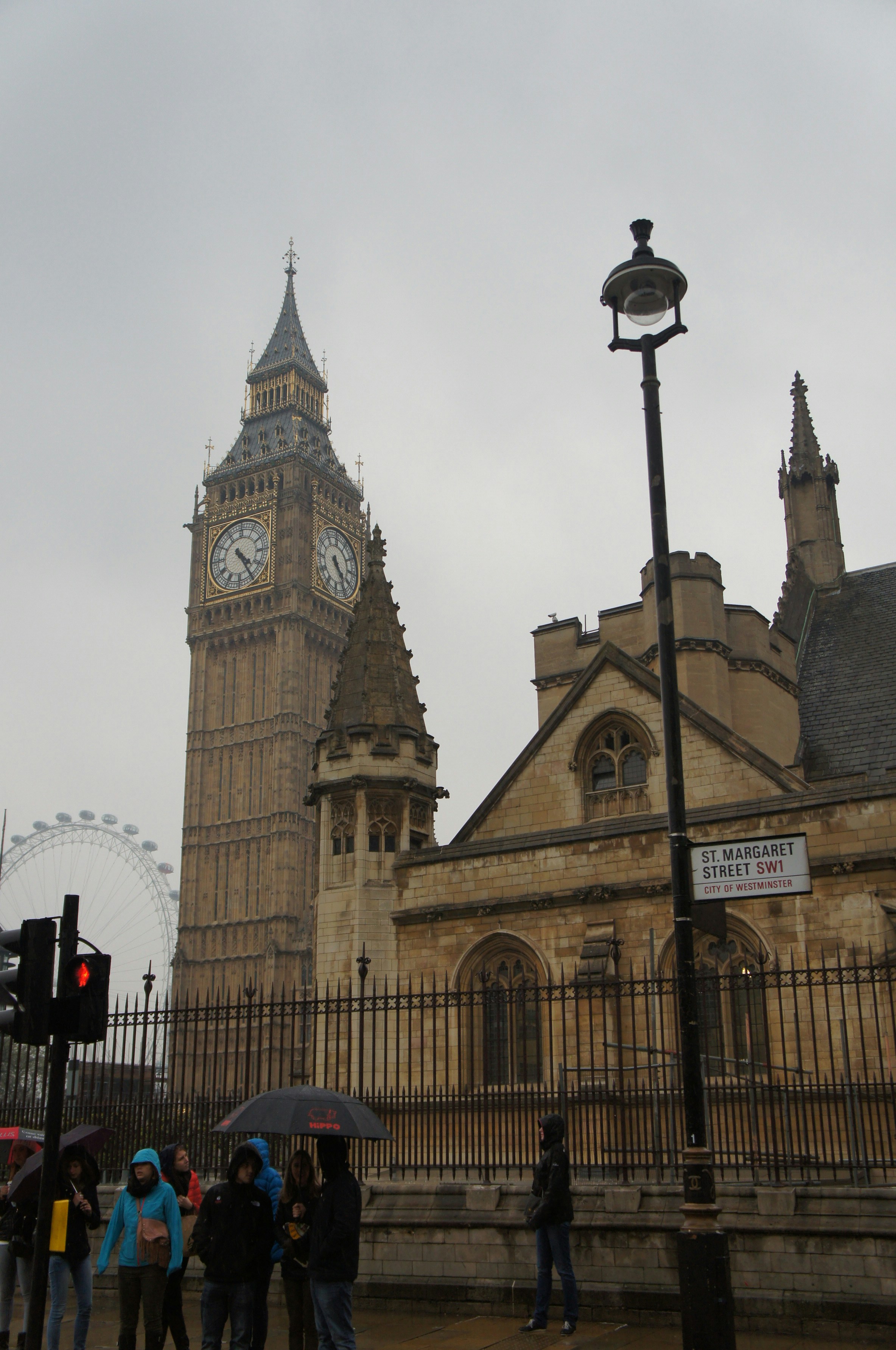 A group of people standing in front of a clock tower photo – Free ...