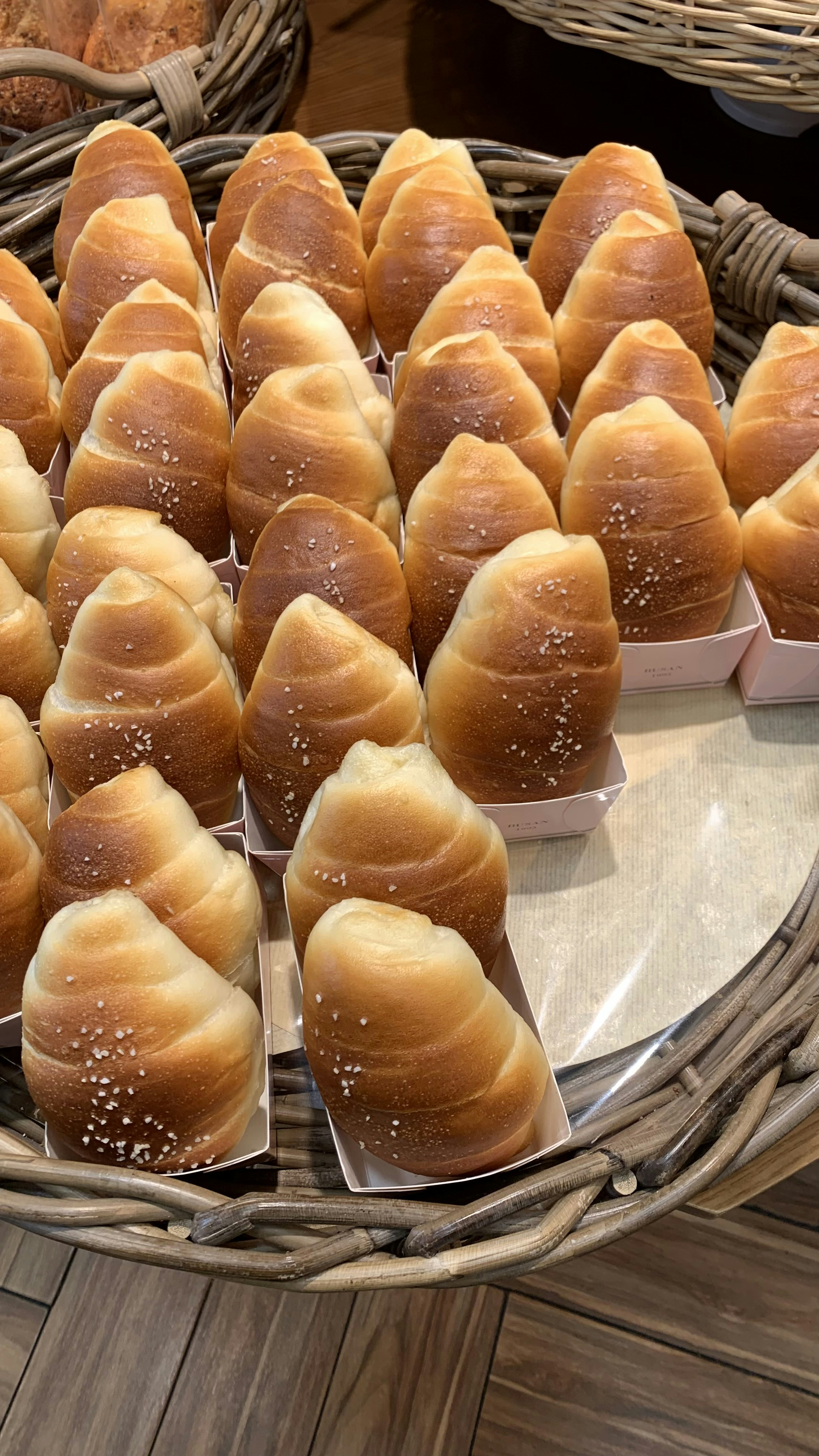 a basket filled with lots of bread on top of a table