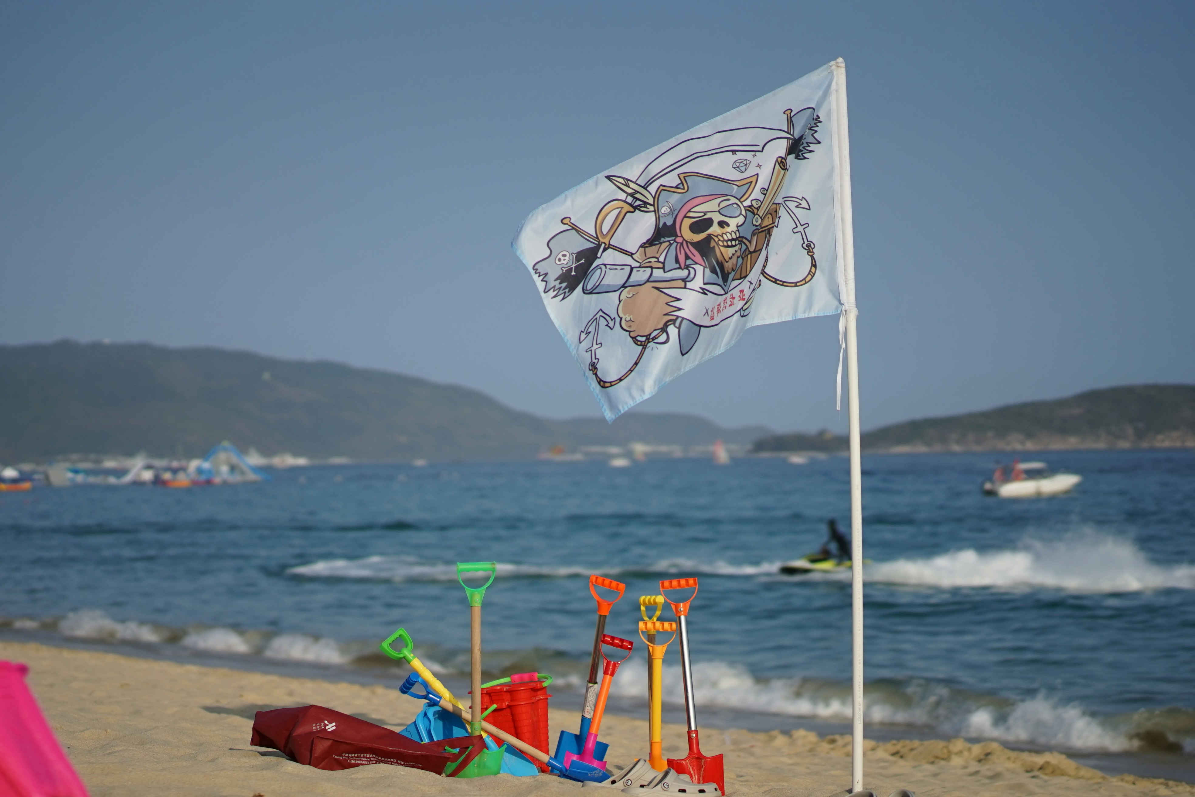 Cartoon Pirate Flag Guards a Toy-Strewn Beach