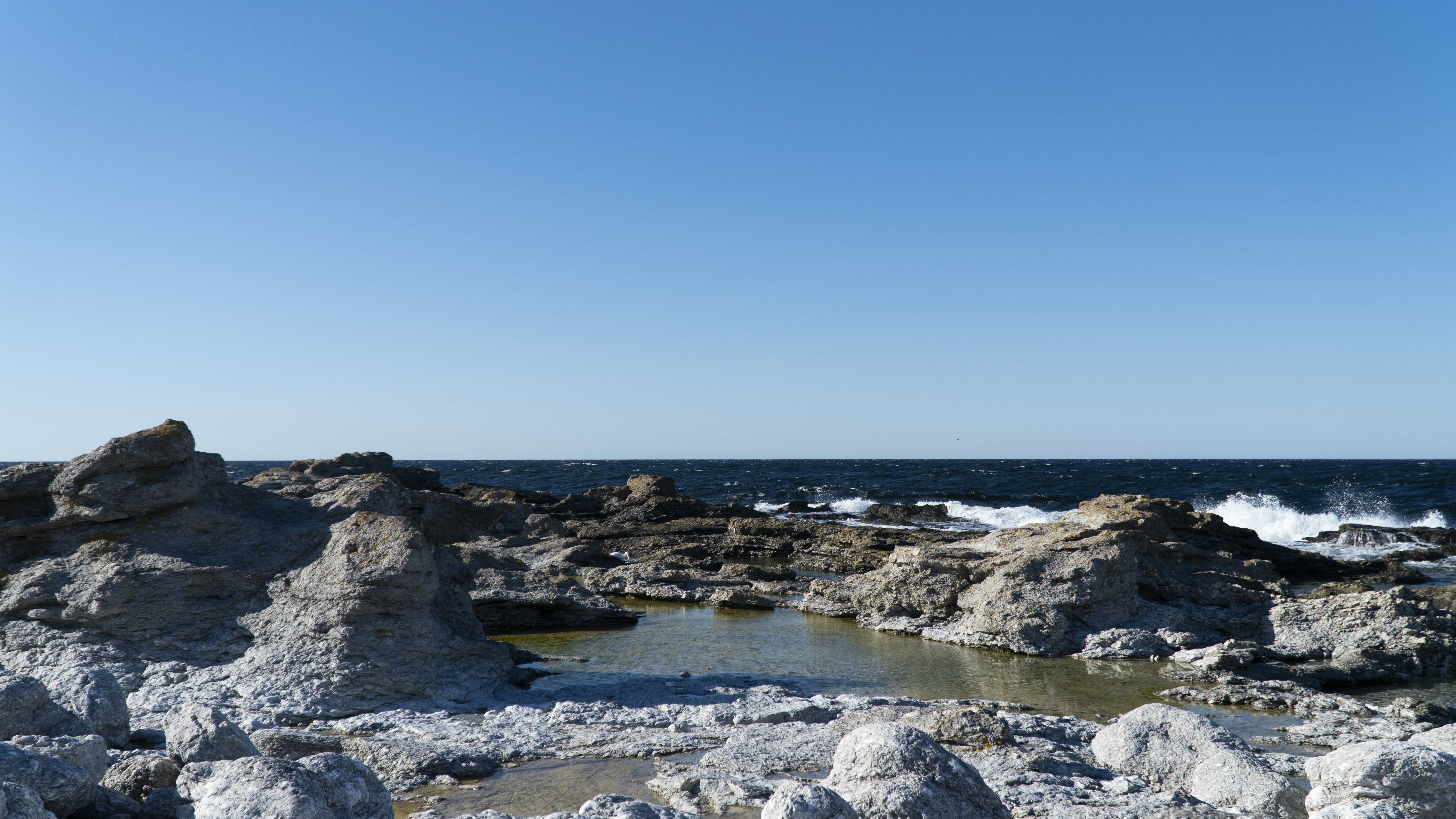 A large body of water surrounded by rocks photo – Free Sweden Image on ...