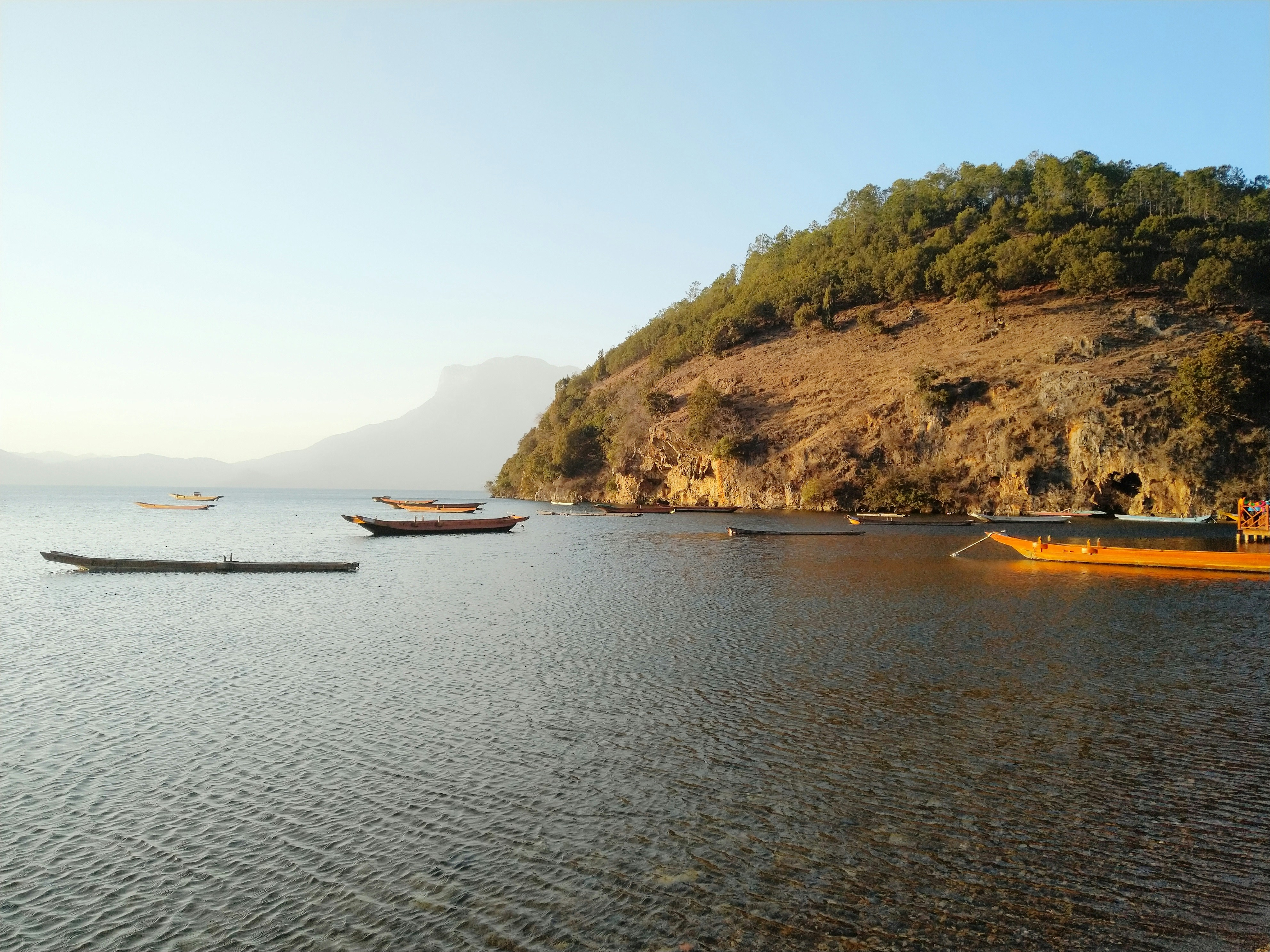 a group of boats floating on top of a lake