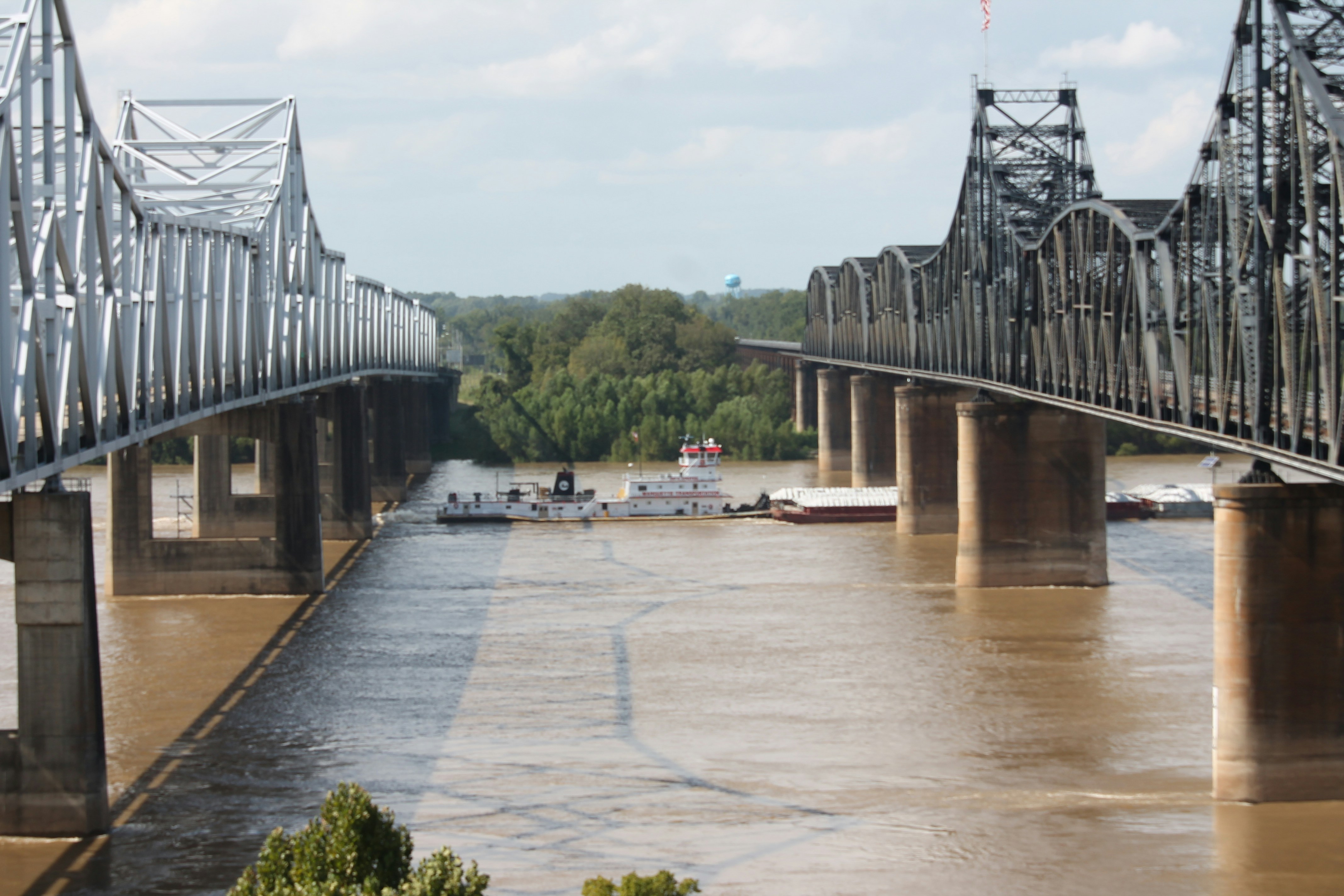A bridge over a river with boats on it photo – Free Mississippi river ...