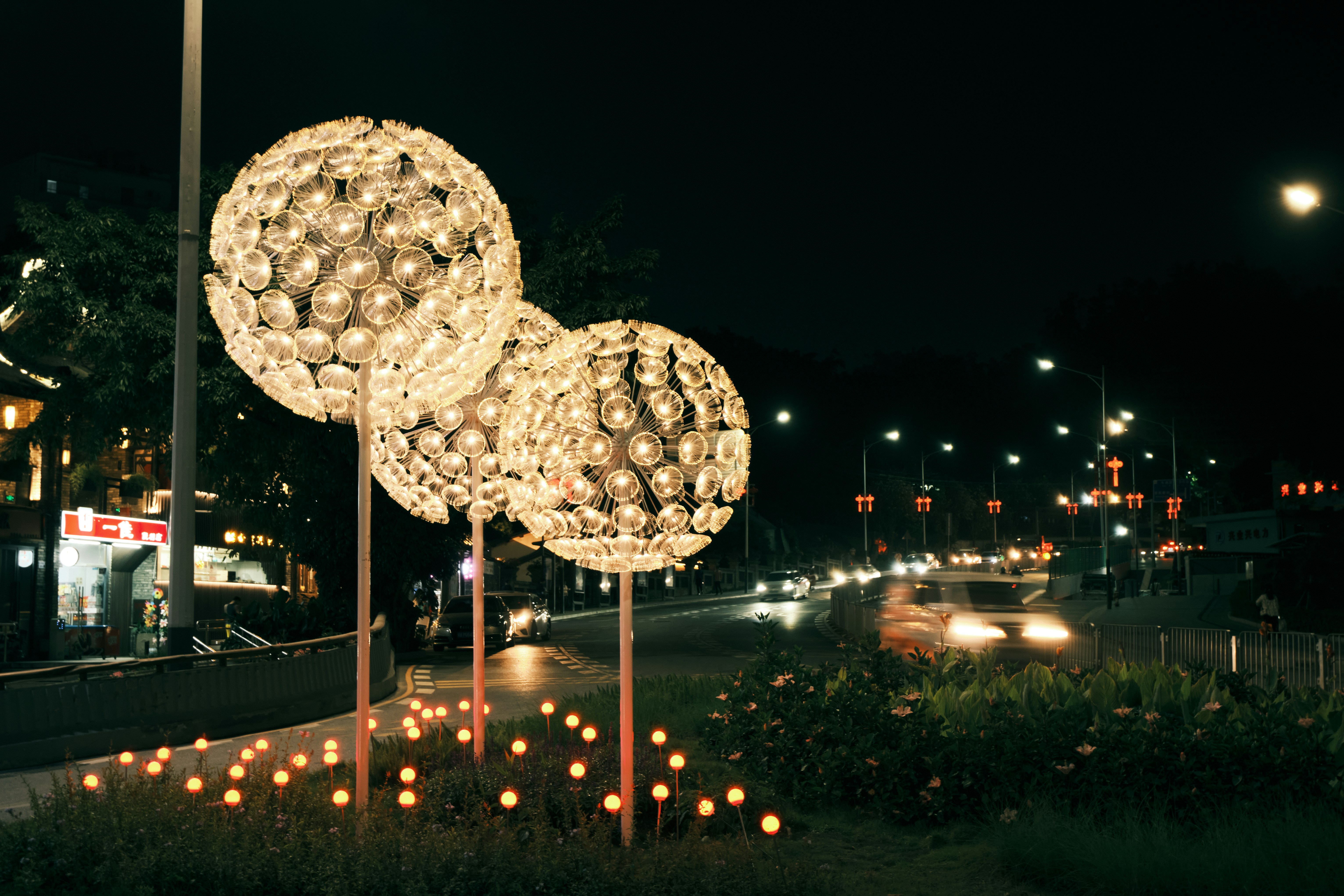 Night Orbit: Glass-Globe Sculptures Lighting a Quiet Street