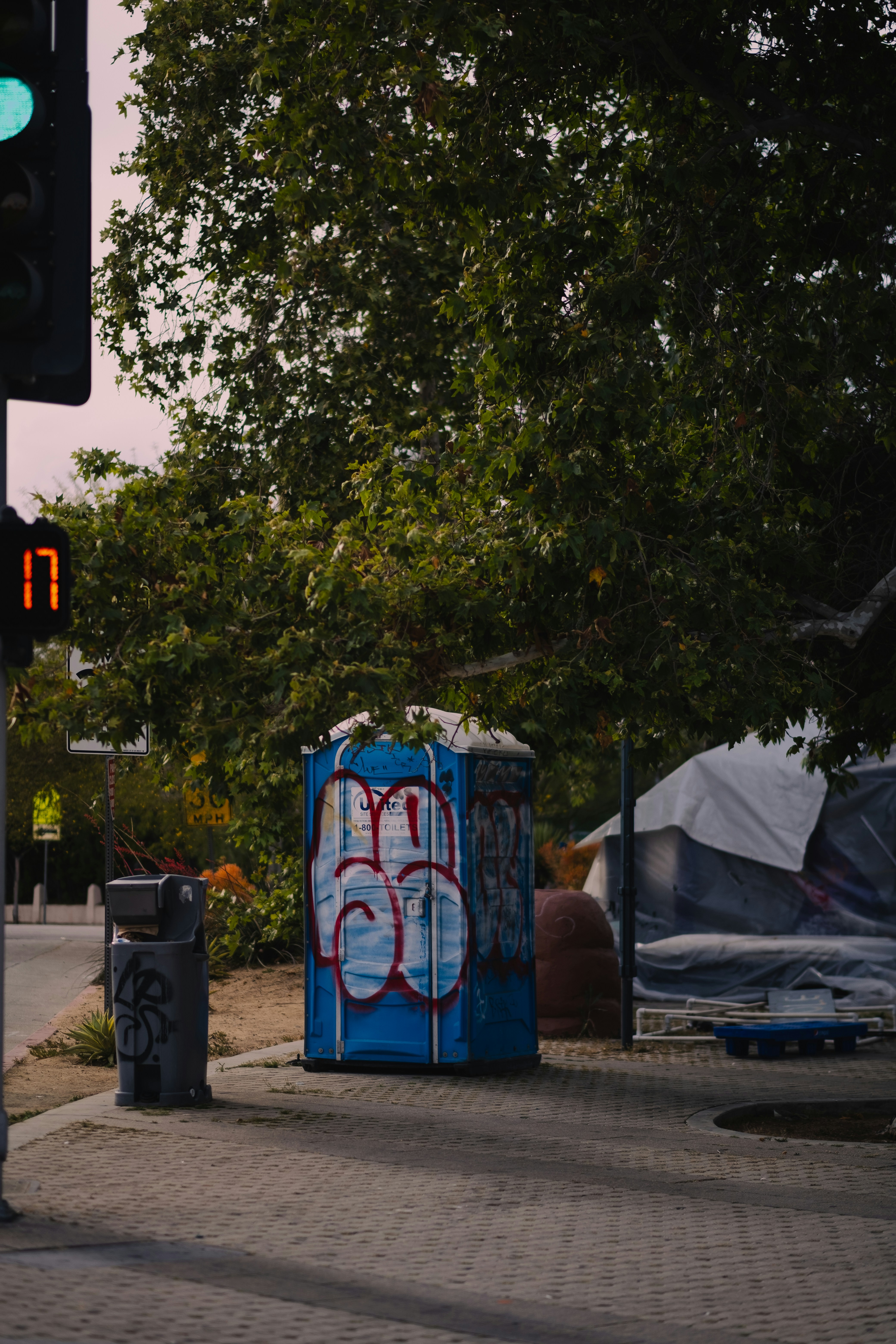 A traffic light on a city street with graffiti on it photo – Free Los ...