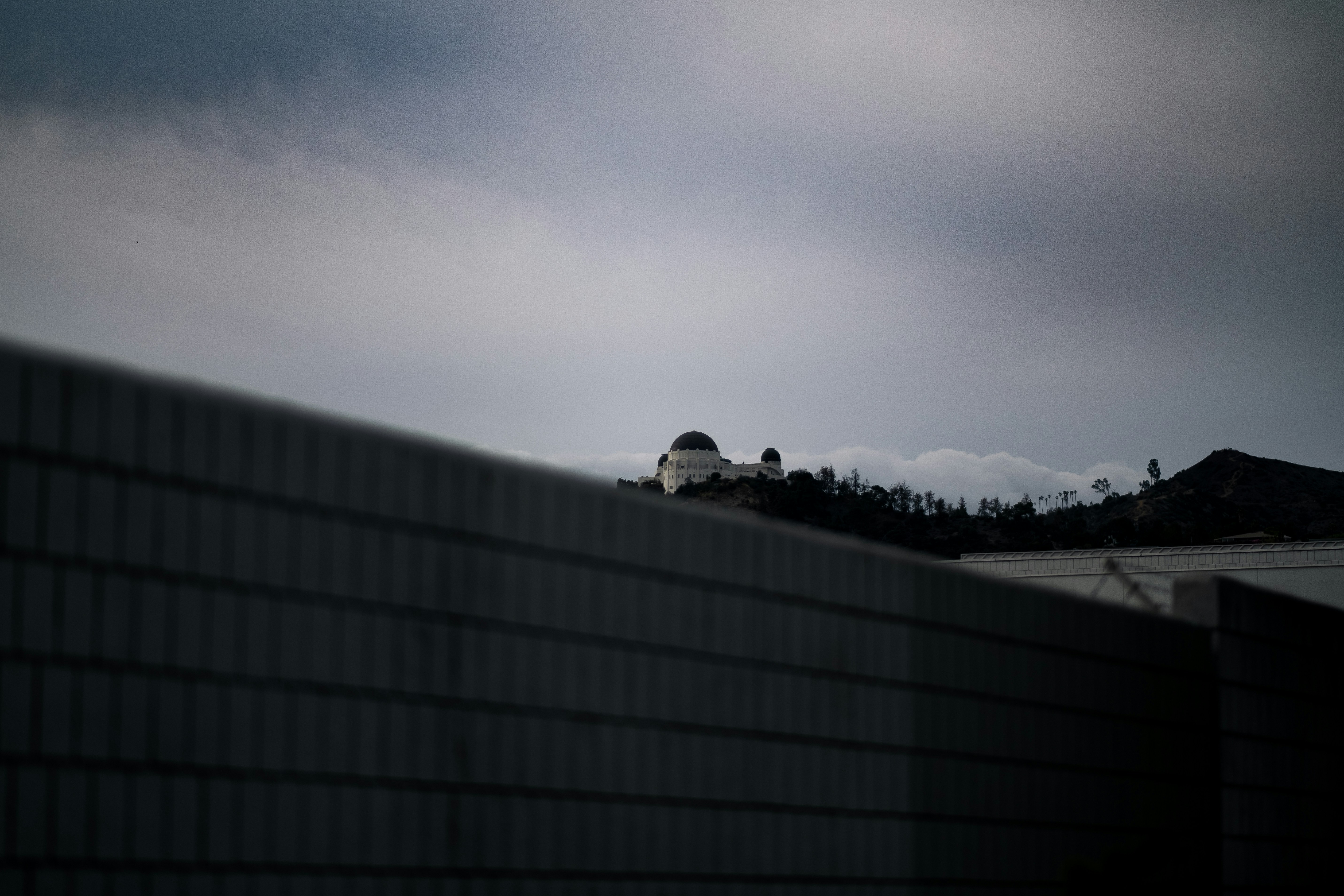 Distant Domes: Silent Watchers Over a Shadowed Skyline