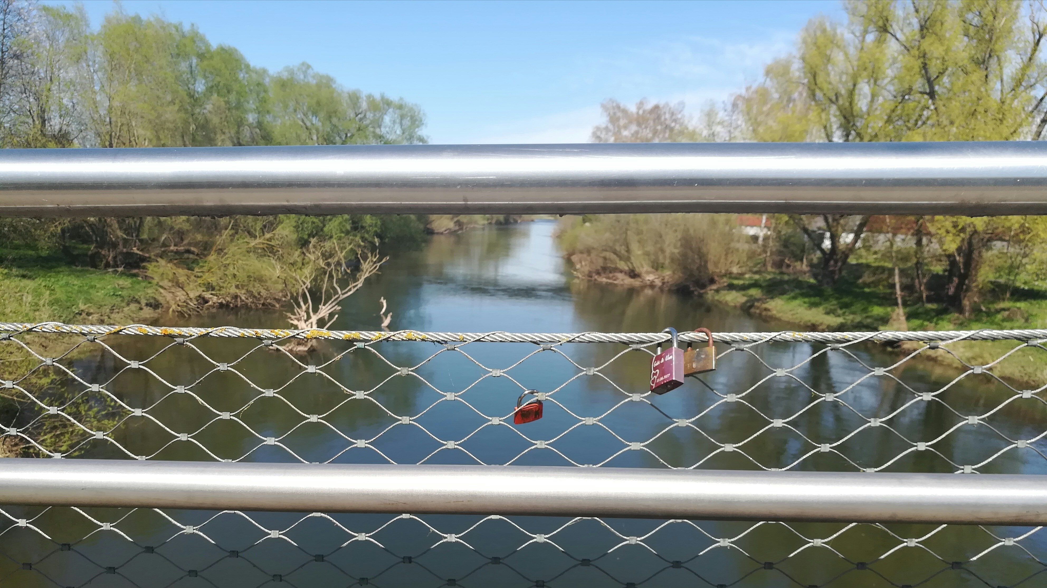 Red Buoy Beyond Diamond Mesh: Riverside Bridge View