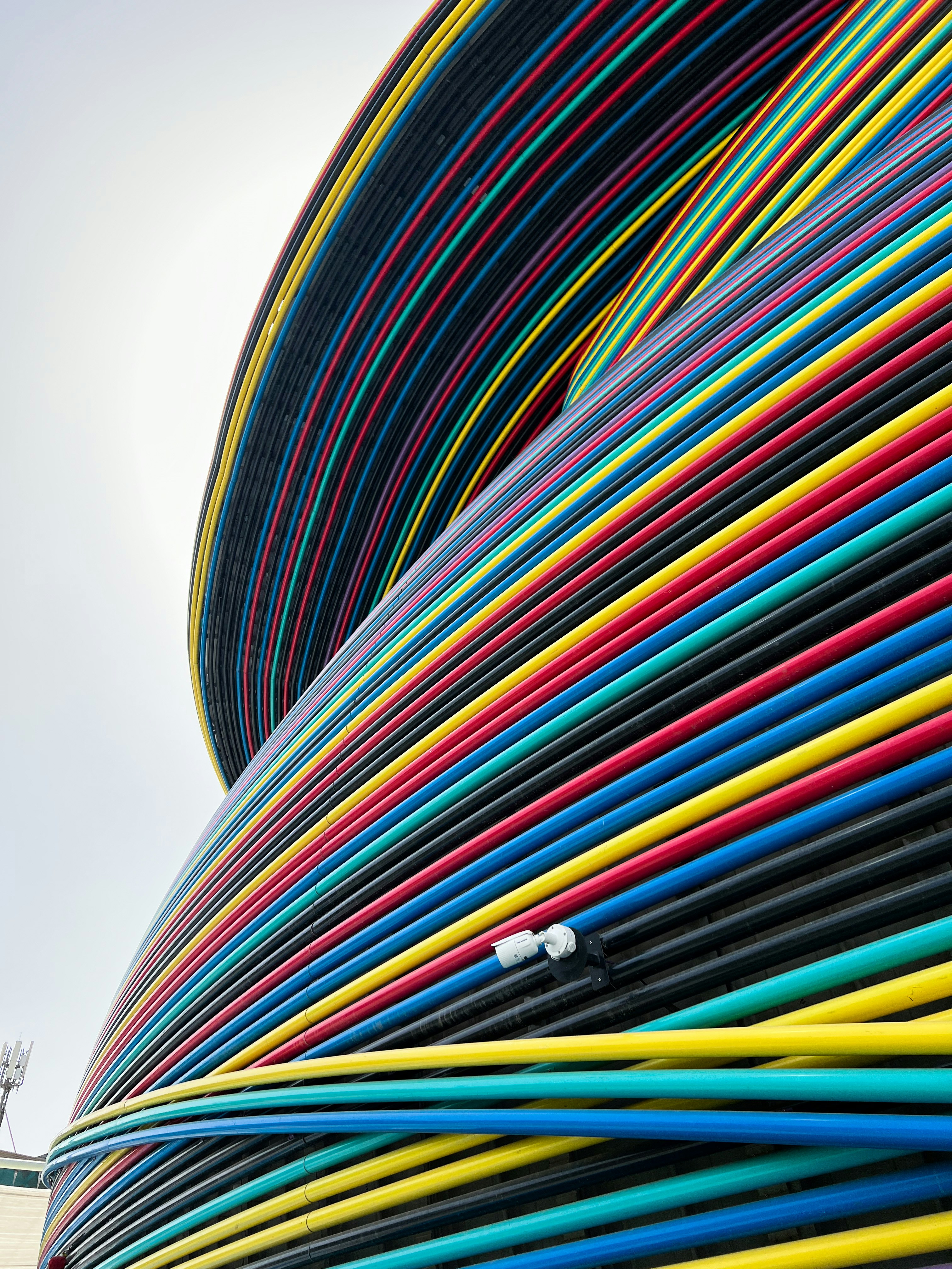 A large stack of colorful hoses sitting on top of a building photo ...