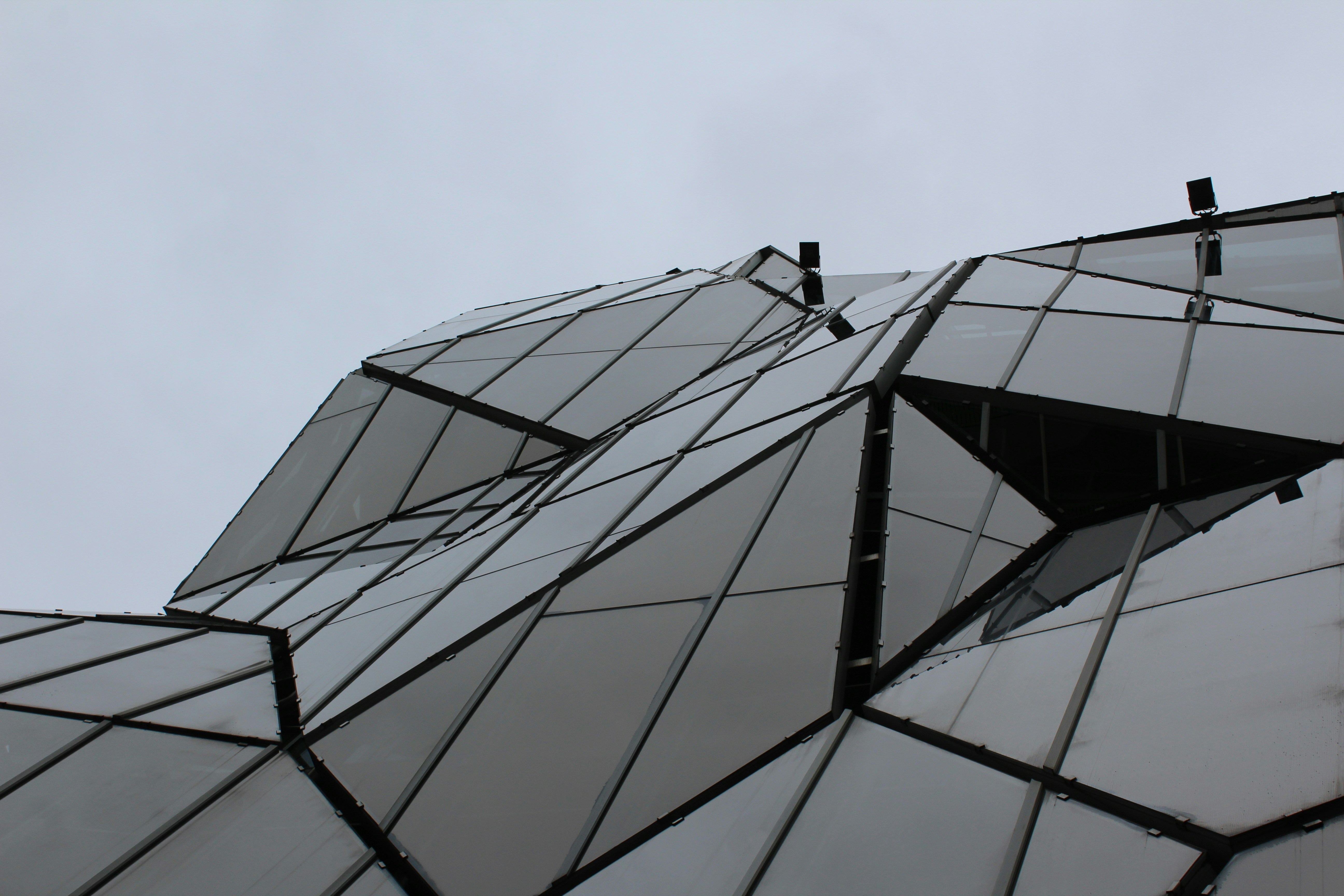 Intersecting Glass Facets: A Tilted Facade's Geometric Dance