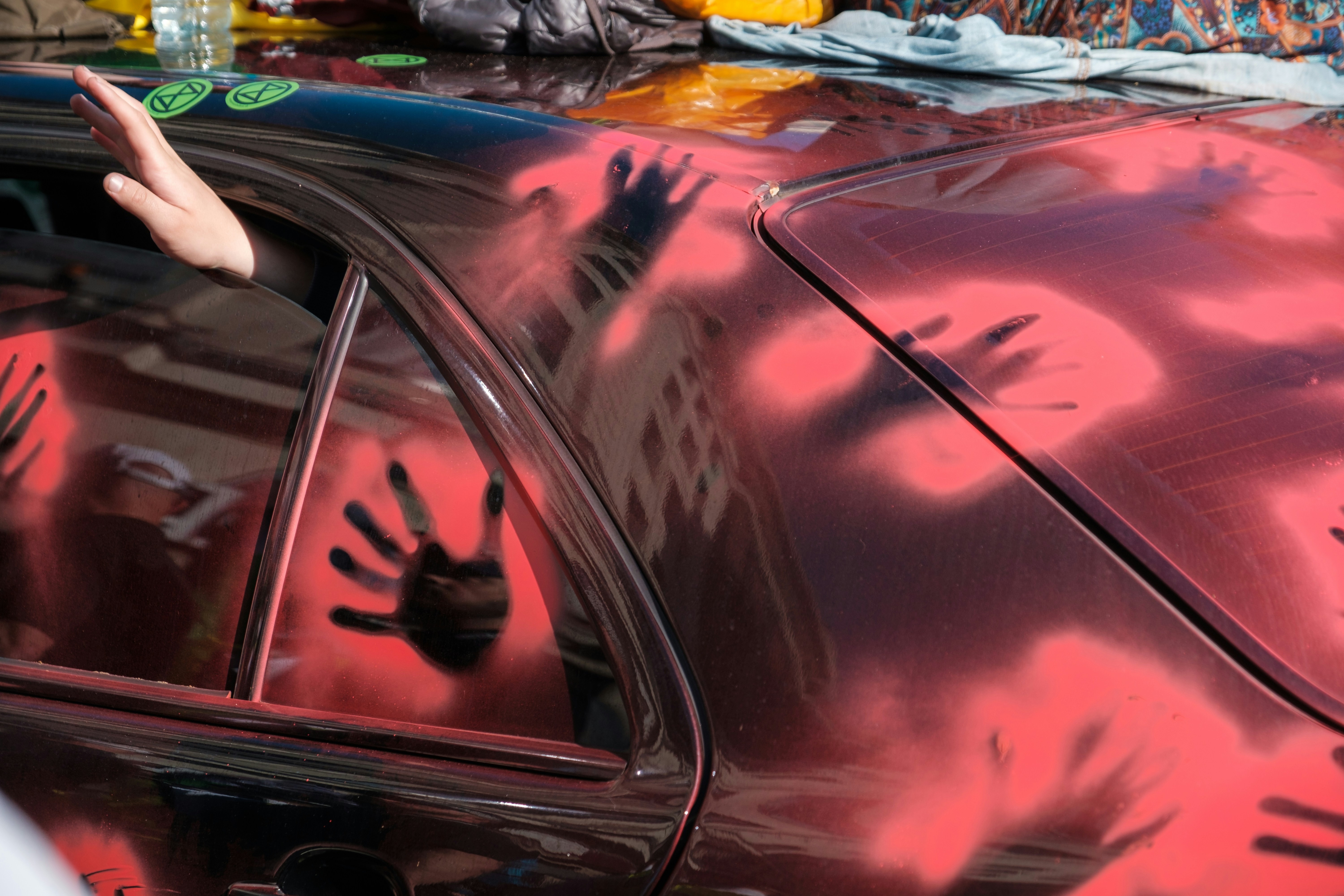A hand print on the side of a red car photo – Free Current events Image ...
