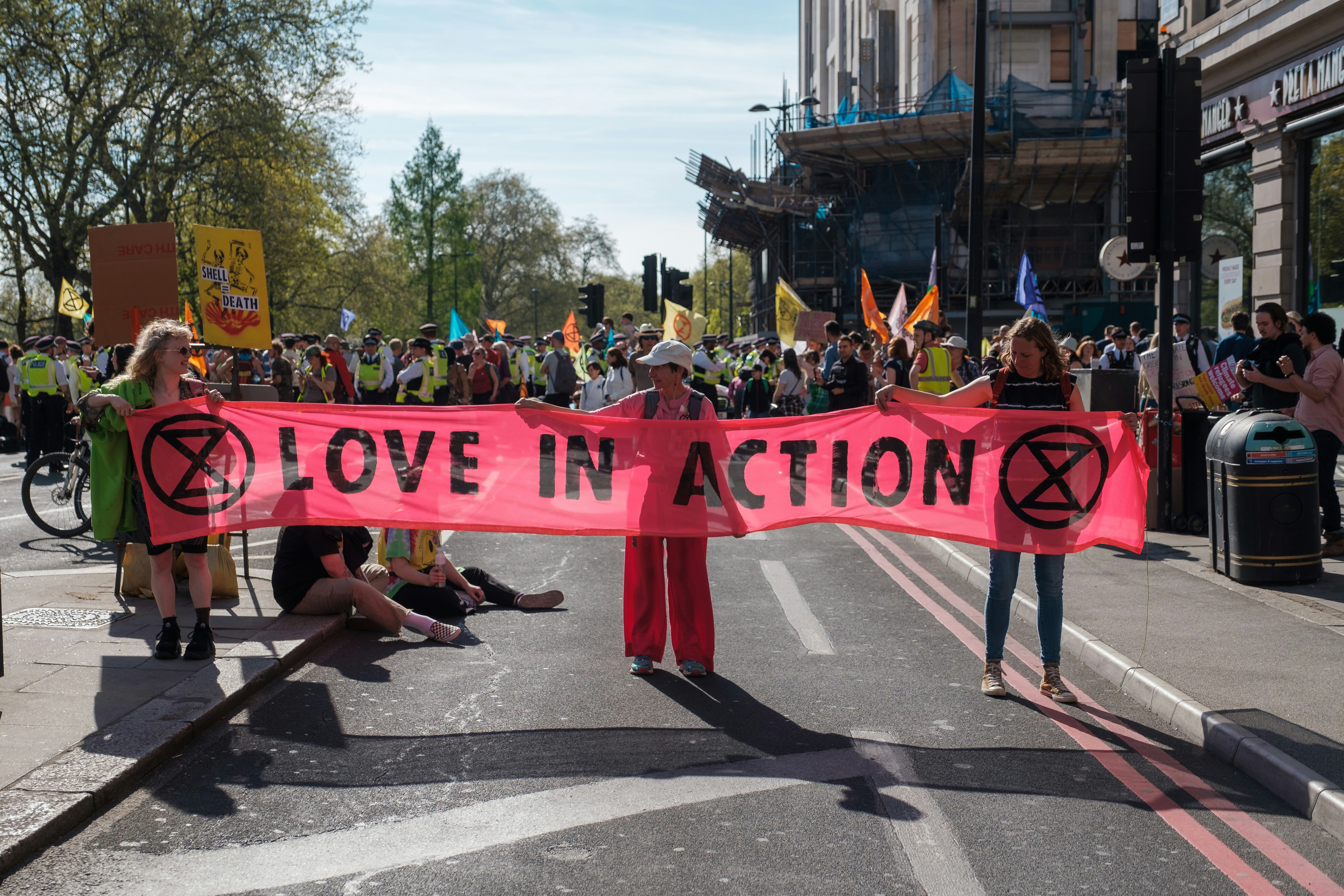 A group of people holding a pink protest sign photo – Free Uk Image on ...