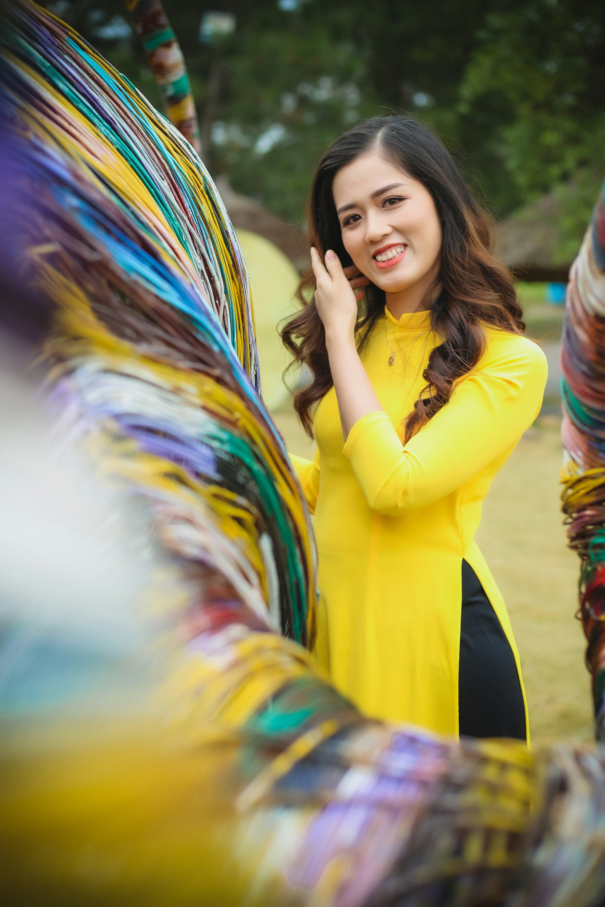 A woman standing next to a colorful bird photo – Free Person Image on ...
