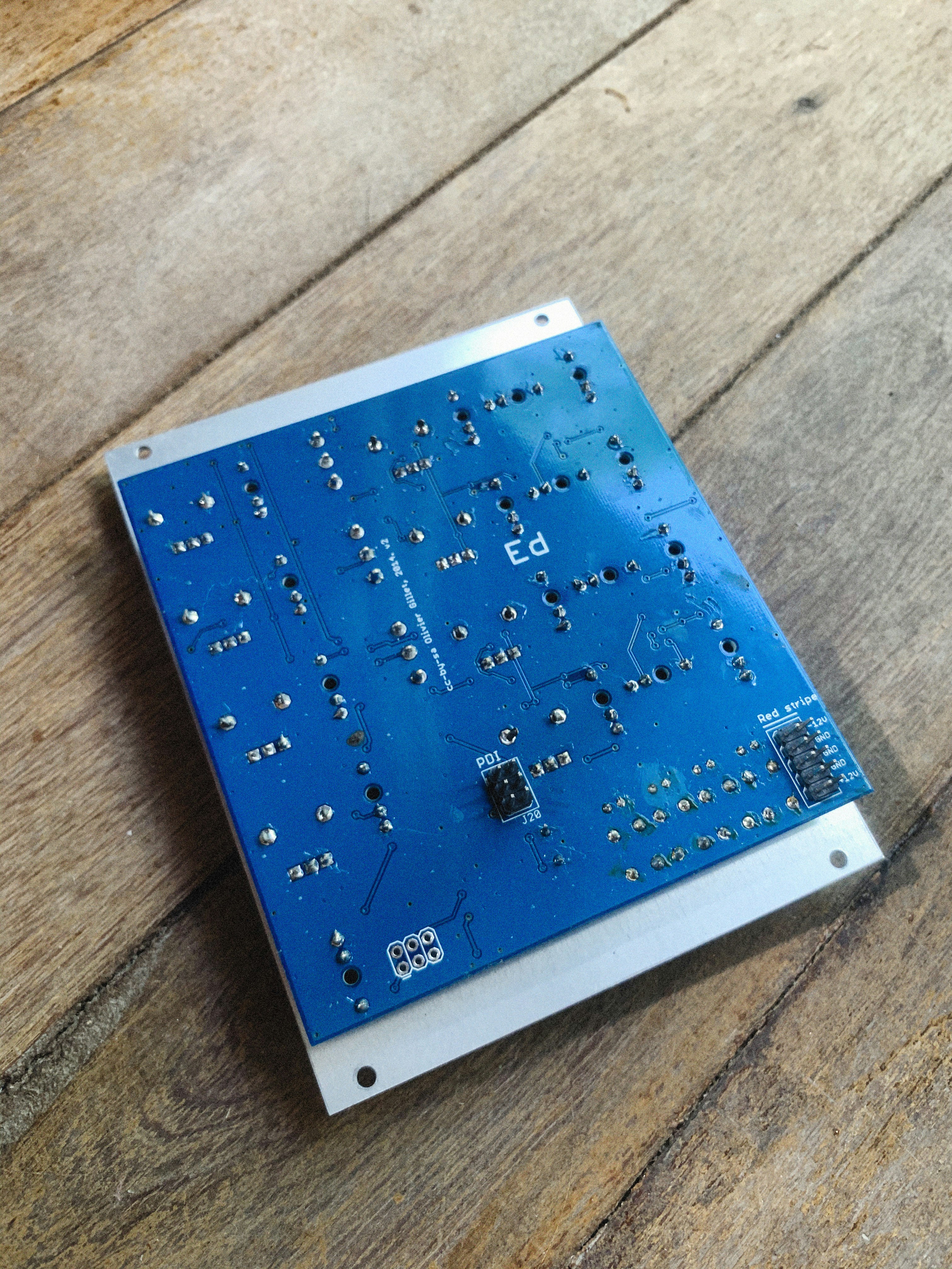 Blue Circuitboard on Weathered Wood: A Quiet Micro-Engineering Portrait