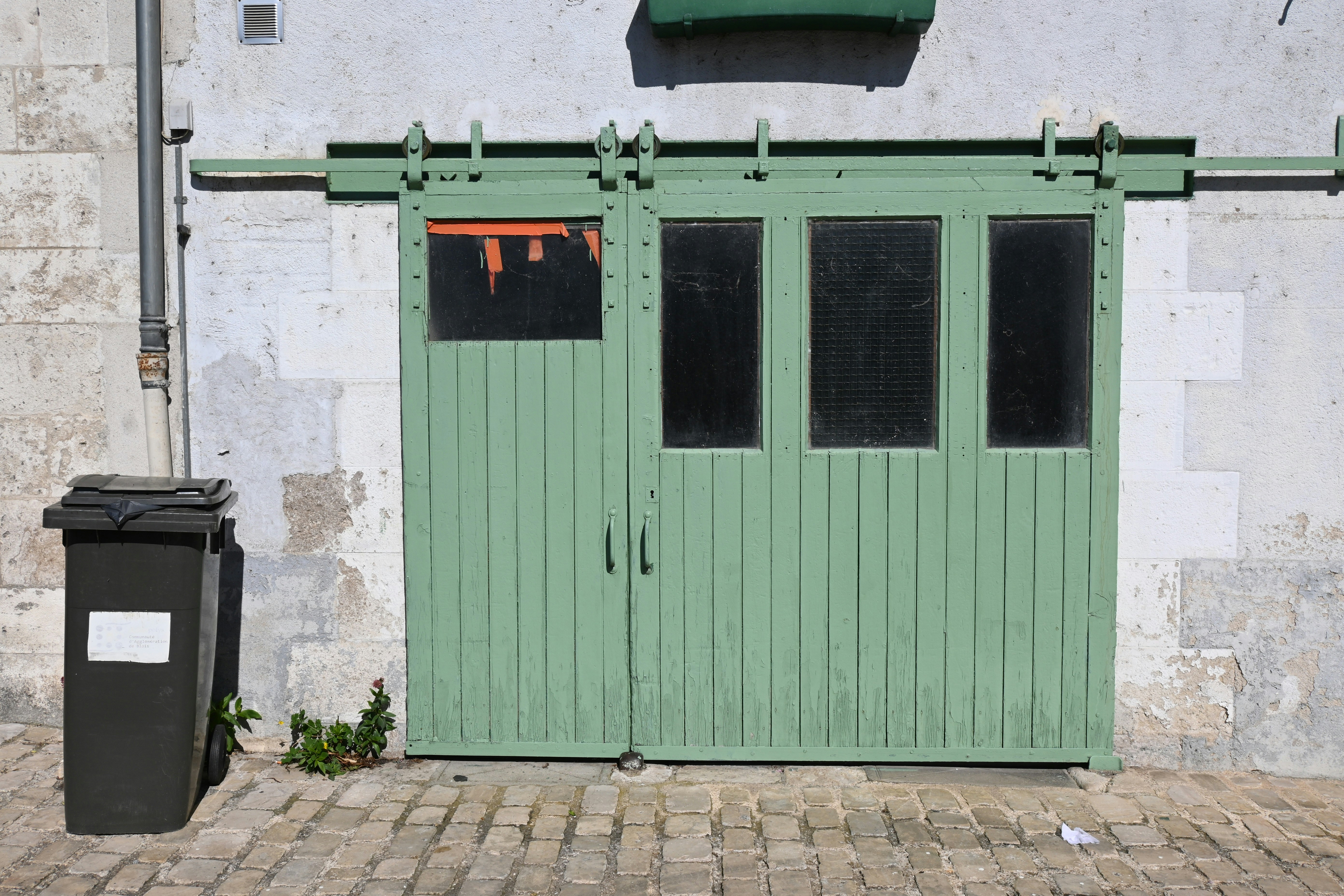 Charming Green Barn Doors Against Stone Facade
