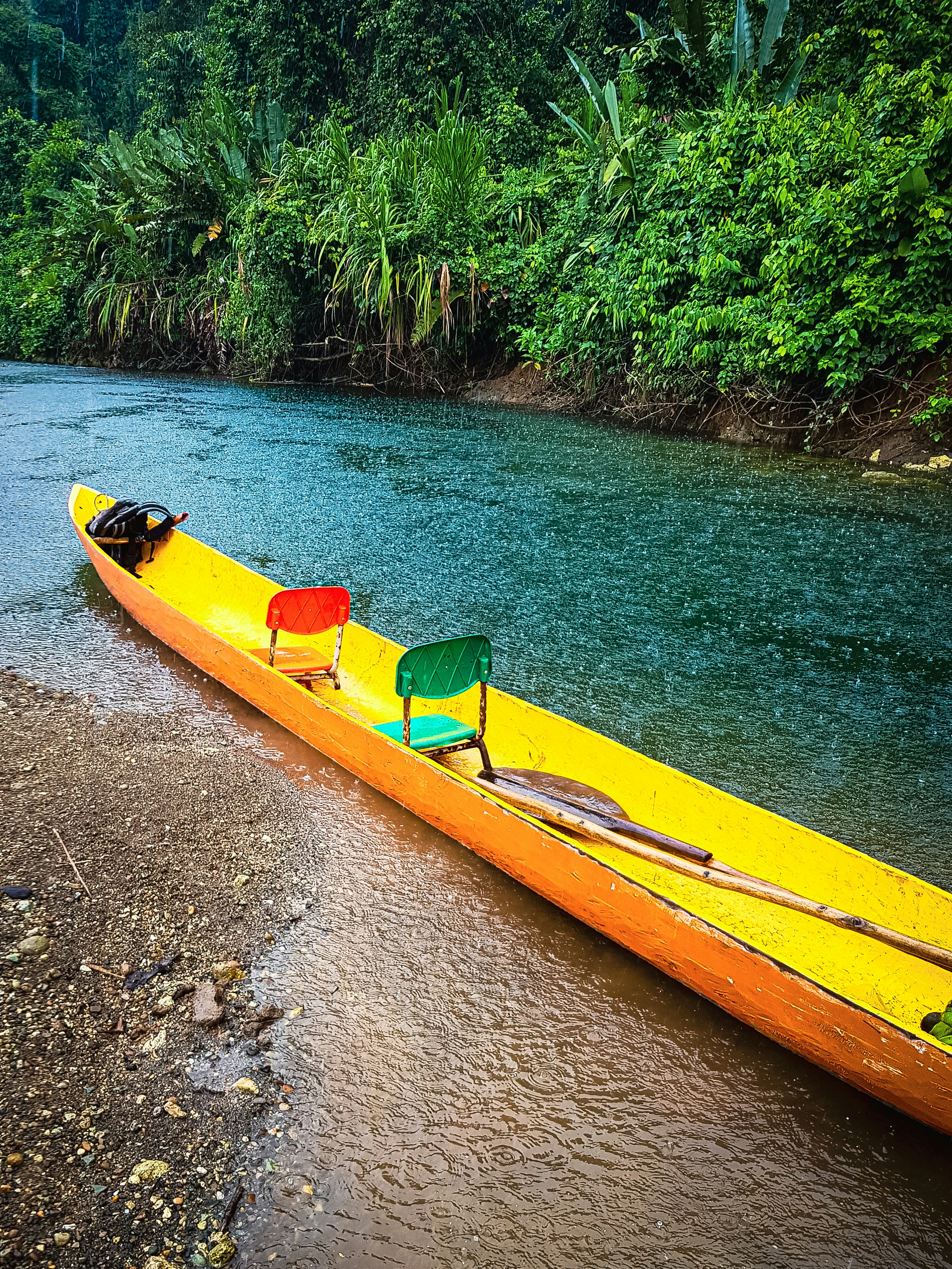 A yellow canoe sitting on the side of a river photo – Free Colombia ...