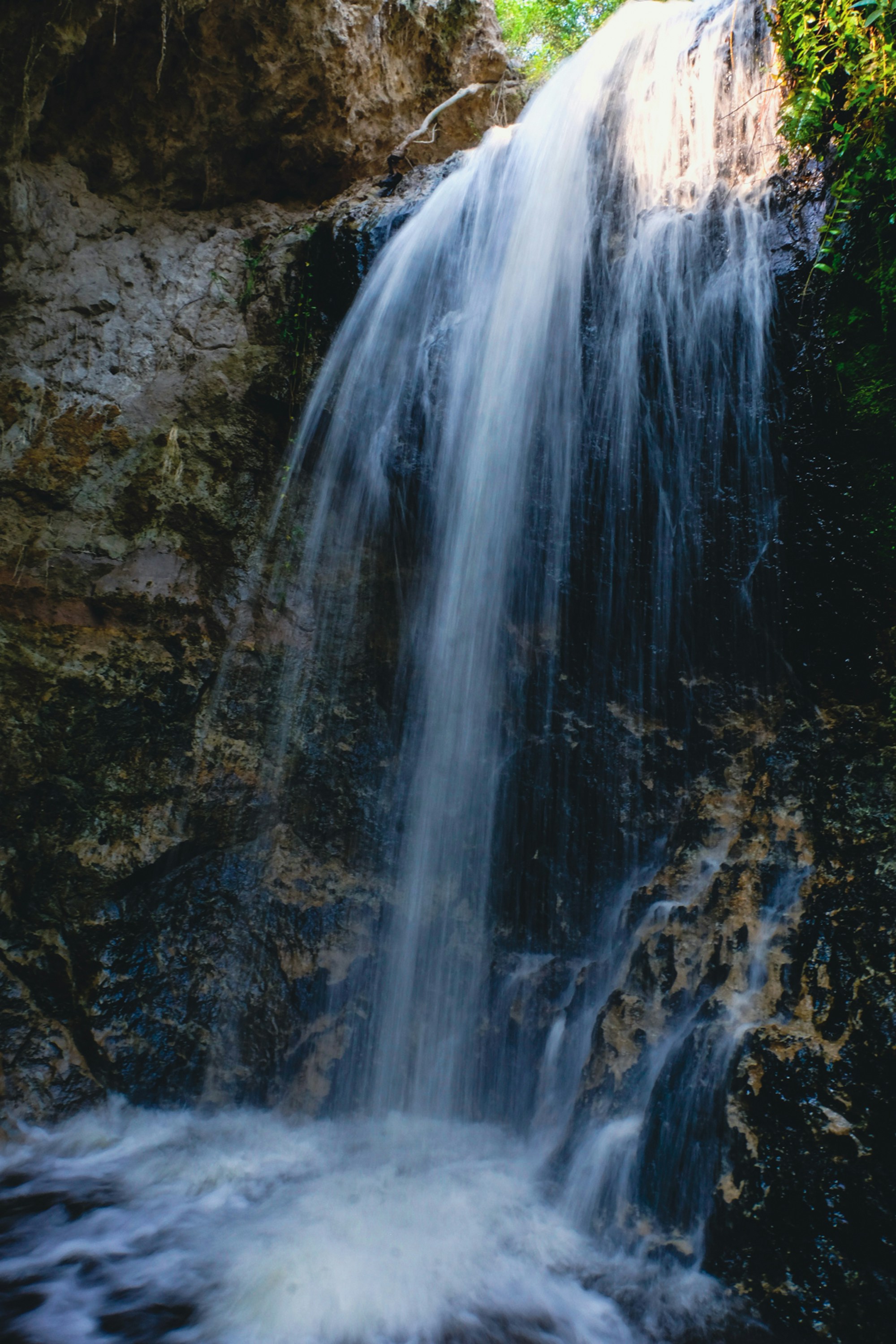 A large waterfall with water cascading down it's sides photo – Free ...